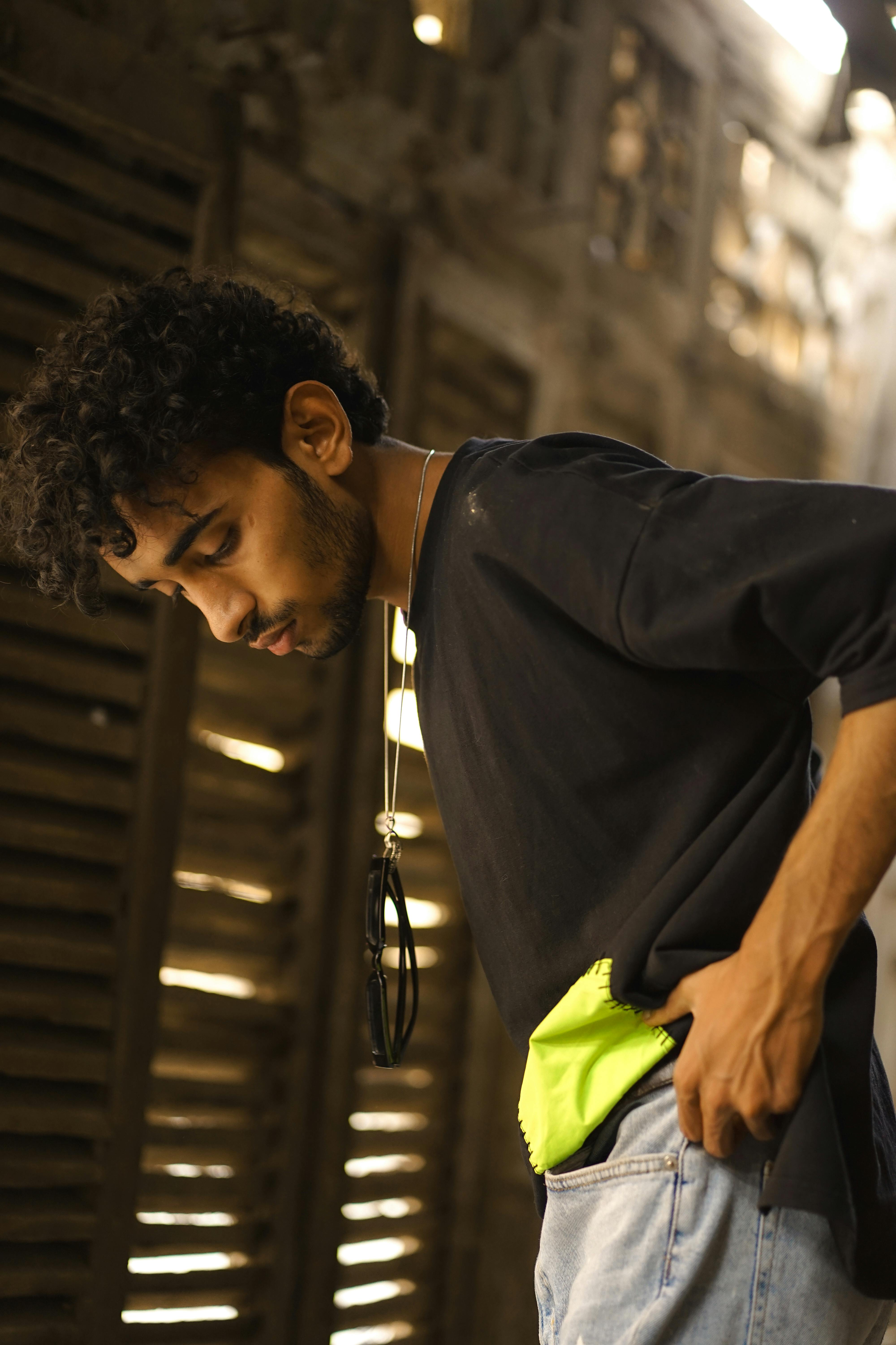 Young Man Putting on Jeans · Free Stock Photo