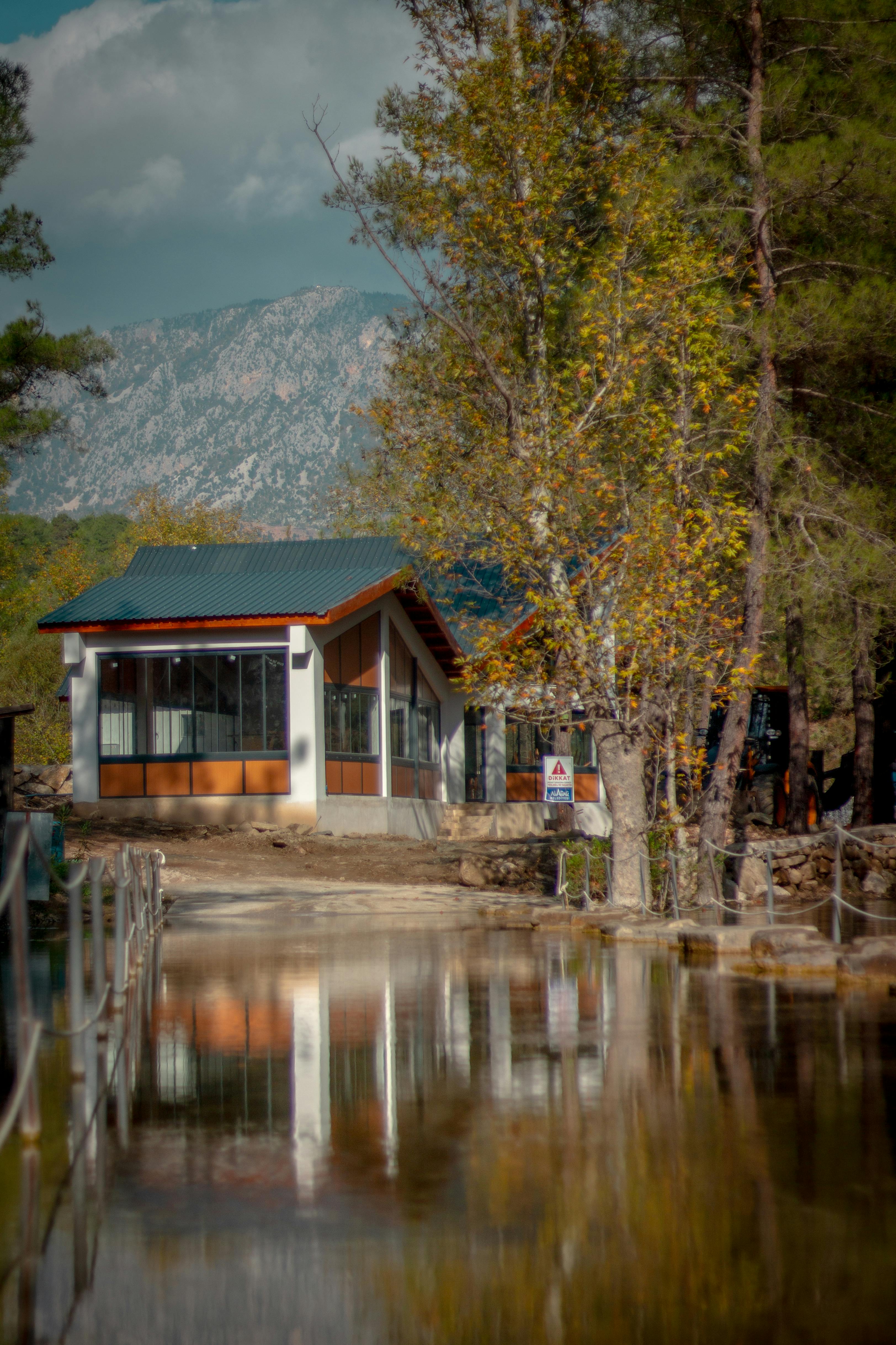 Modern Huts by a Pond in a Mountain Landscape · Free Stock Photo