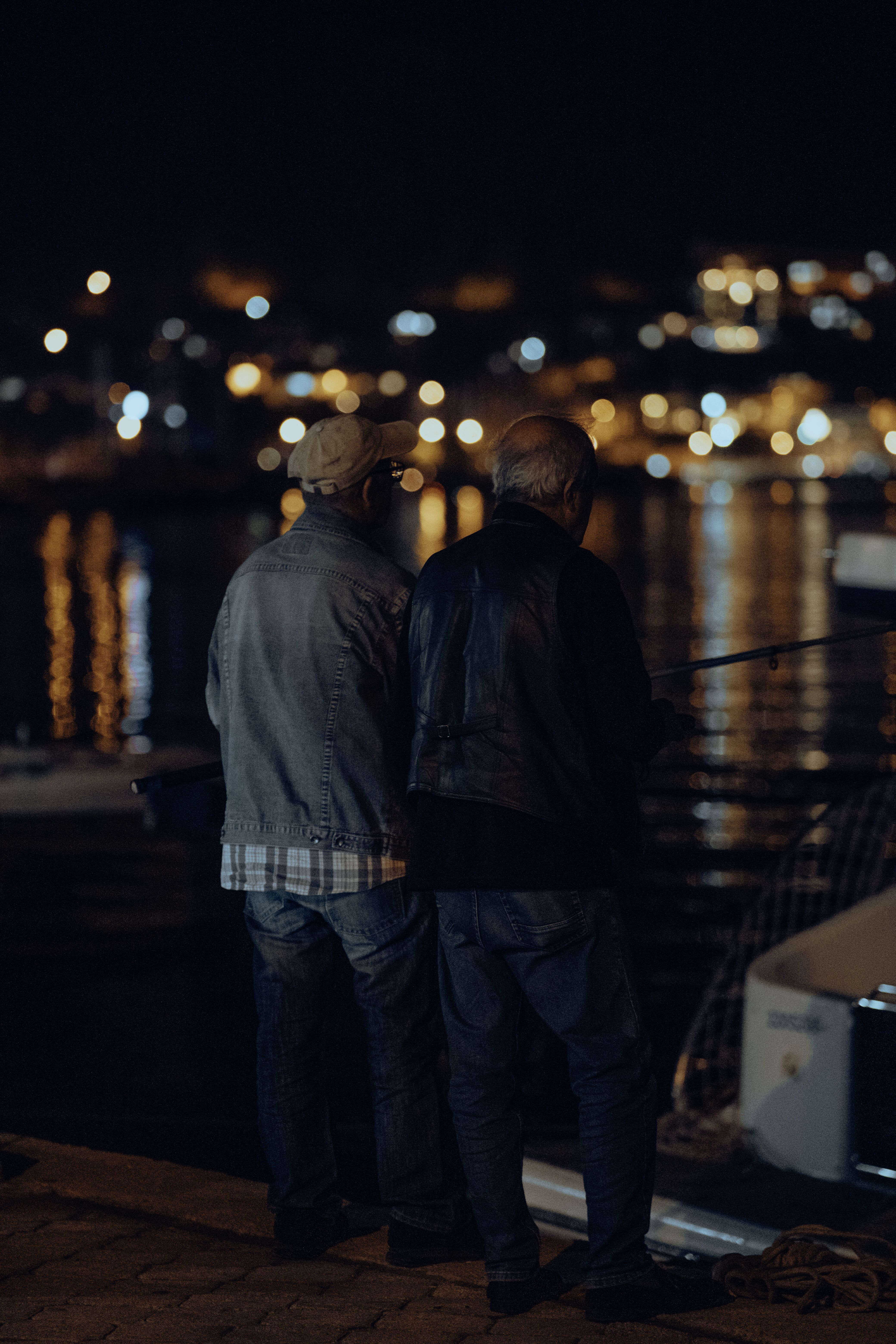 Dark Photo of Men Standing by a Pond at Night · Free Stock Photo