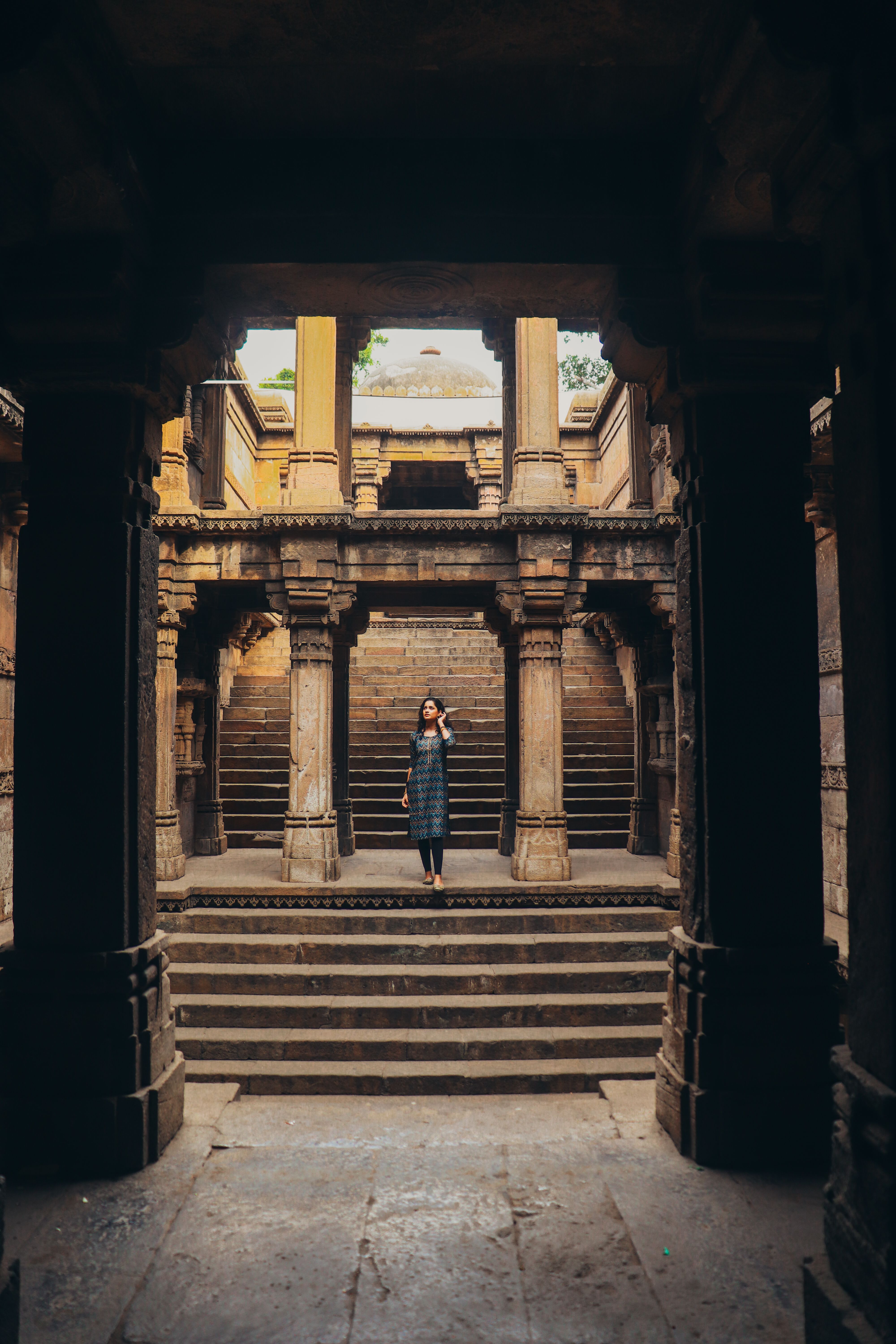 Woman Standing on Stairs in Stone Historic Temple · Free Stock Photo