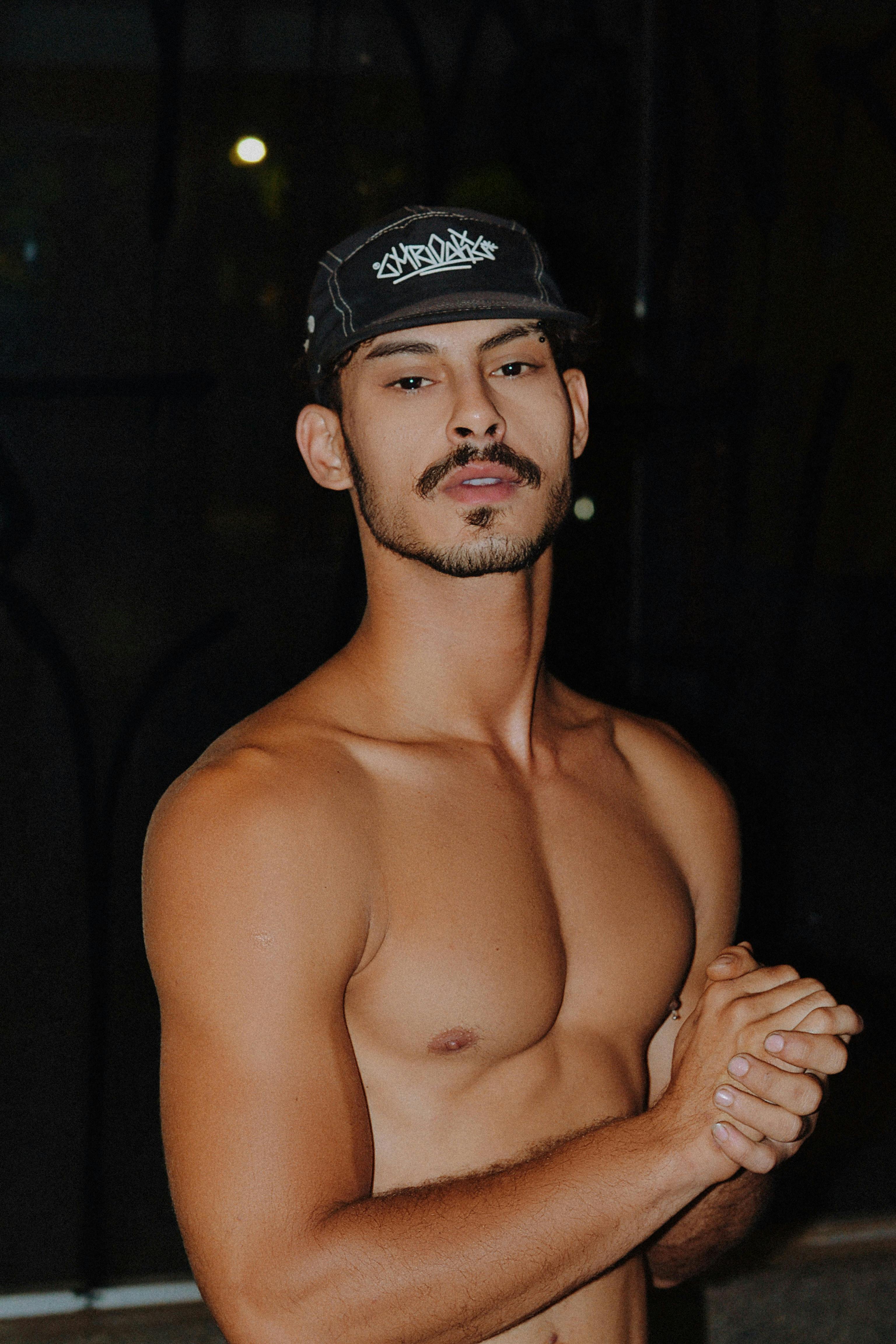 Shirtless Man Wearing a Cap · Free Stock Photo