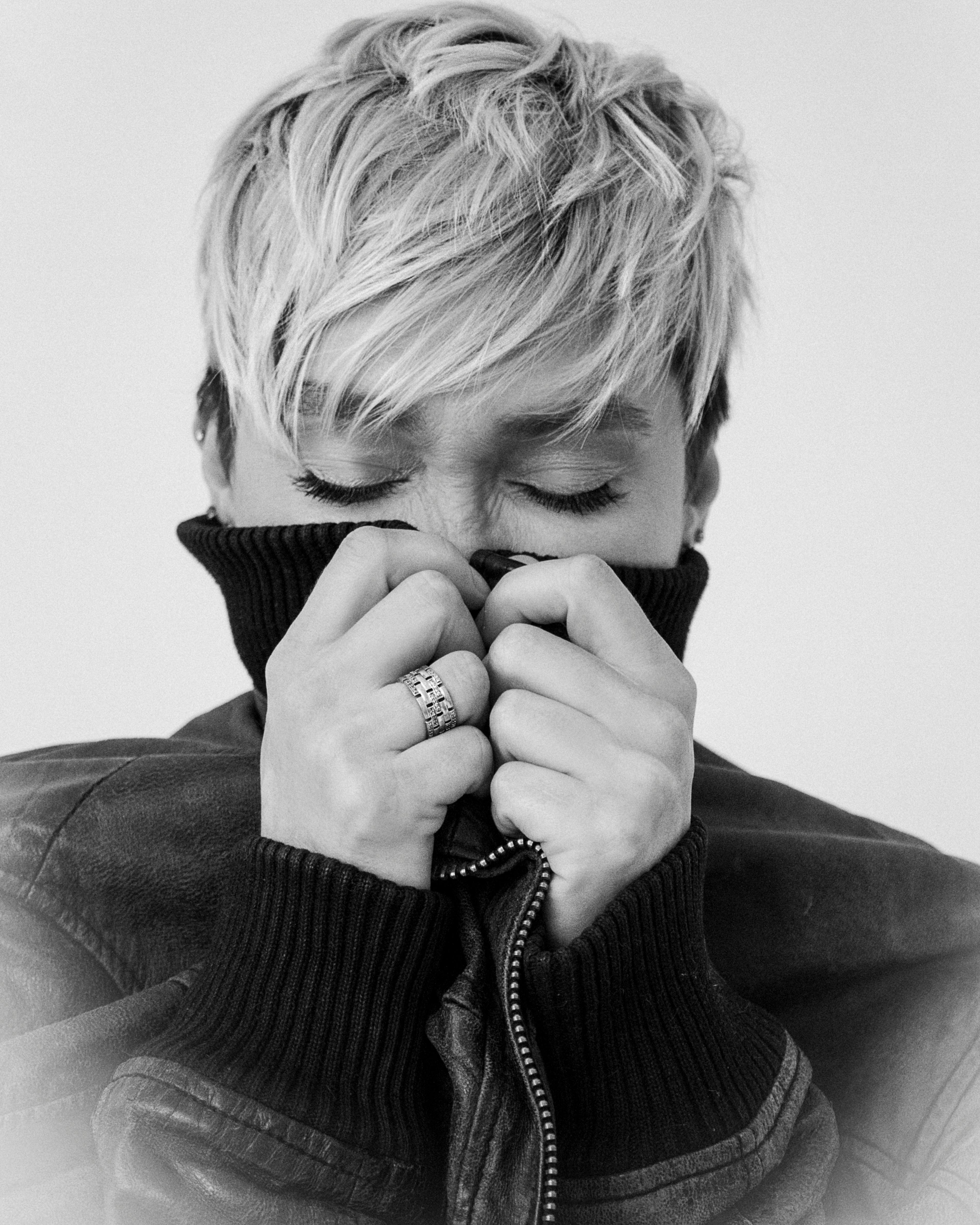 Woman Covering her Face with the Collar of her Jacket · Free Stock Photo