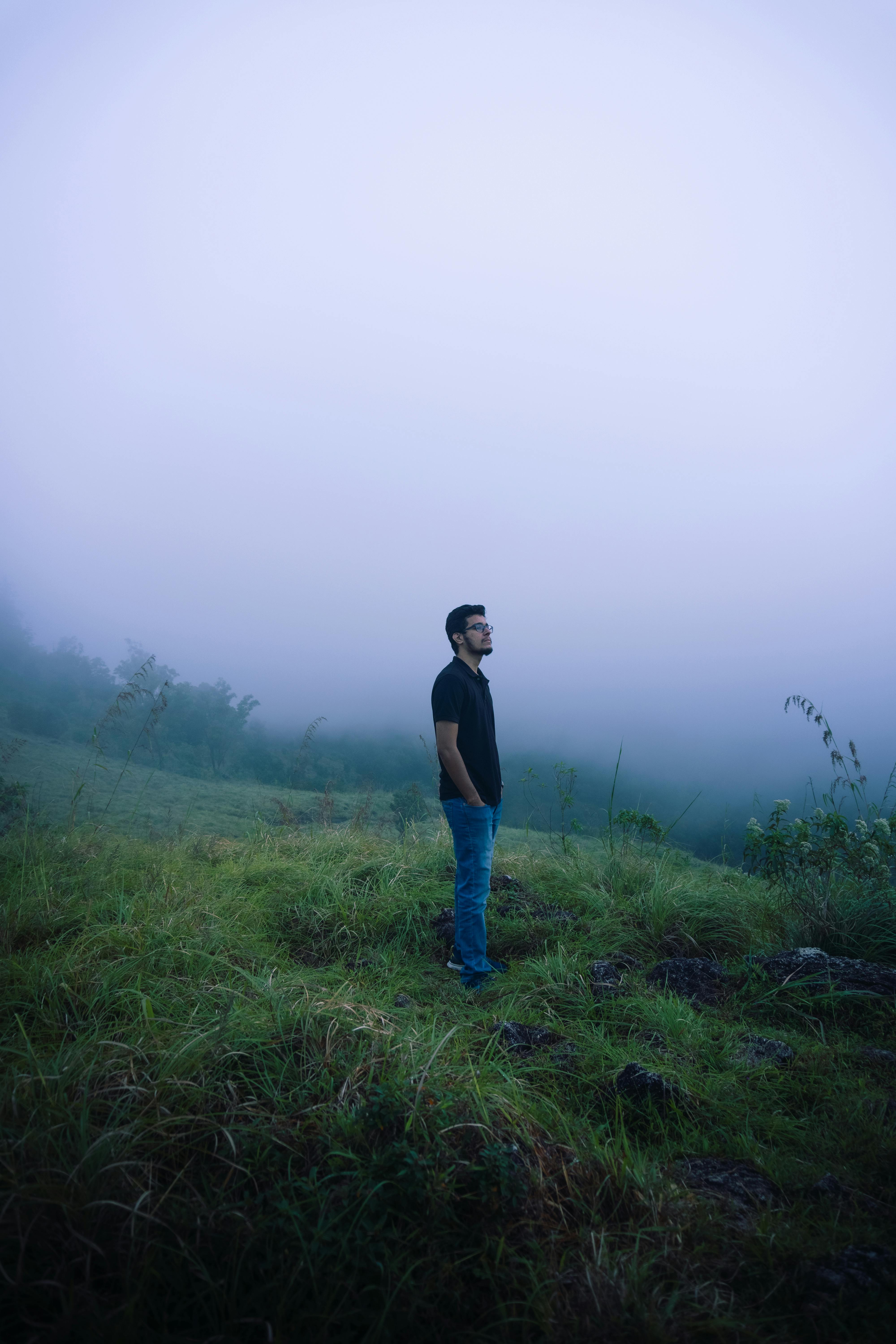 Man Standing on Grass in Nature at Dawn · Free Stock Photo
