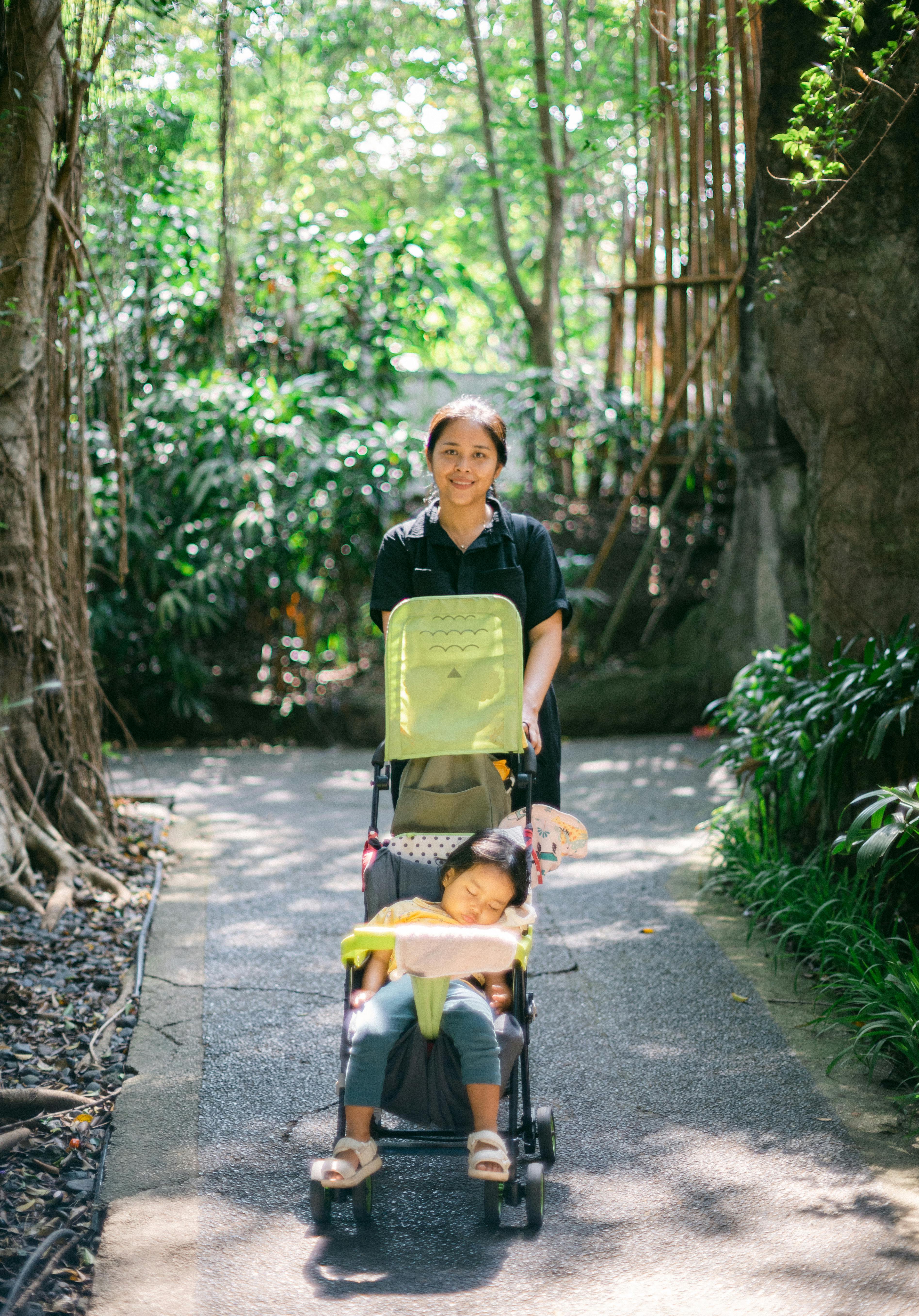Woman Pushing Stroller · Free Stock Photo