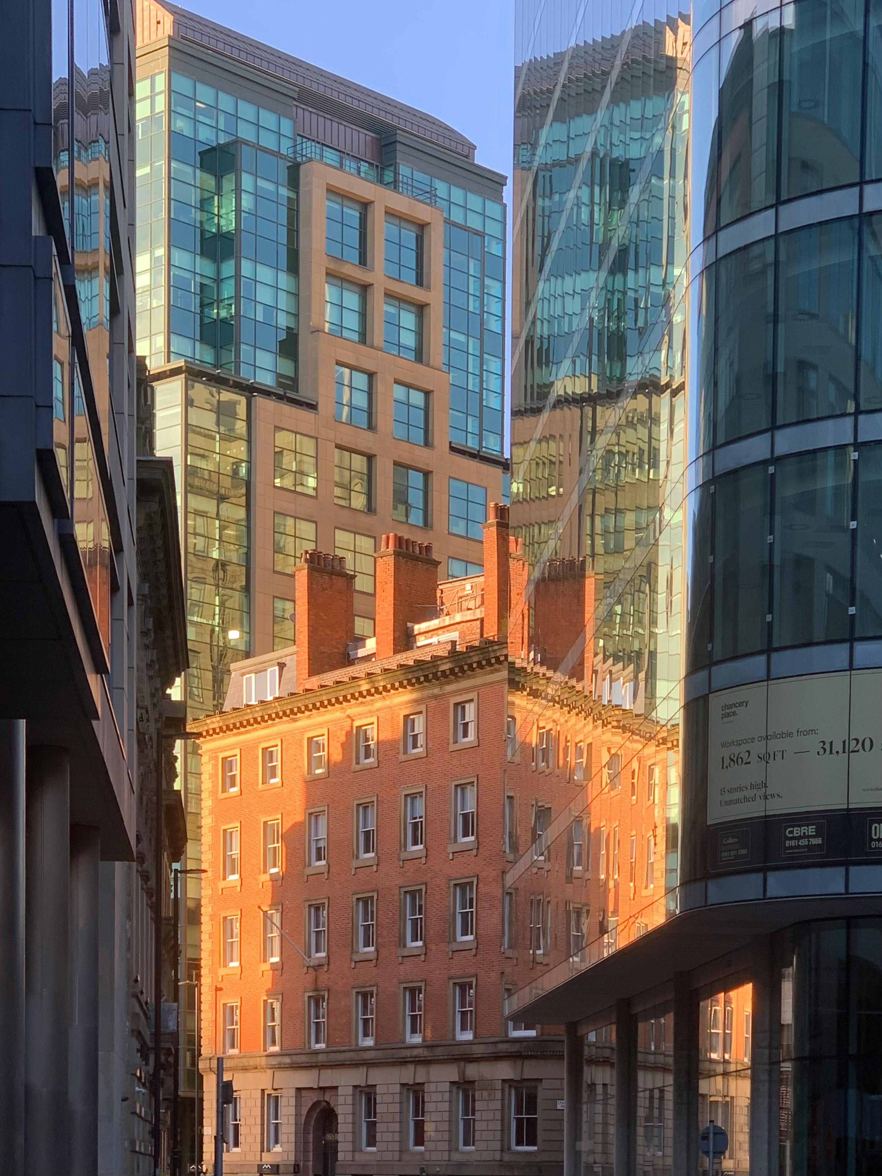 Red Brick Tenement among Modern Buildings in Downtown · Free Stock Photo