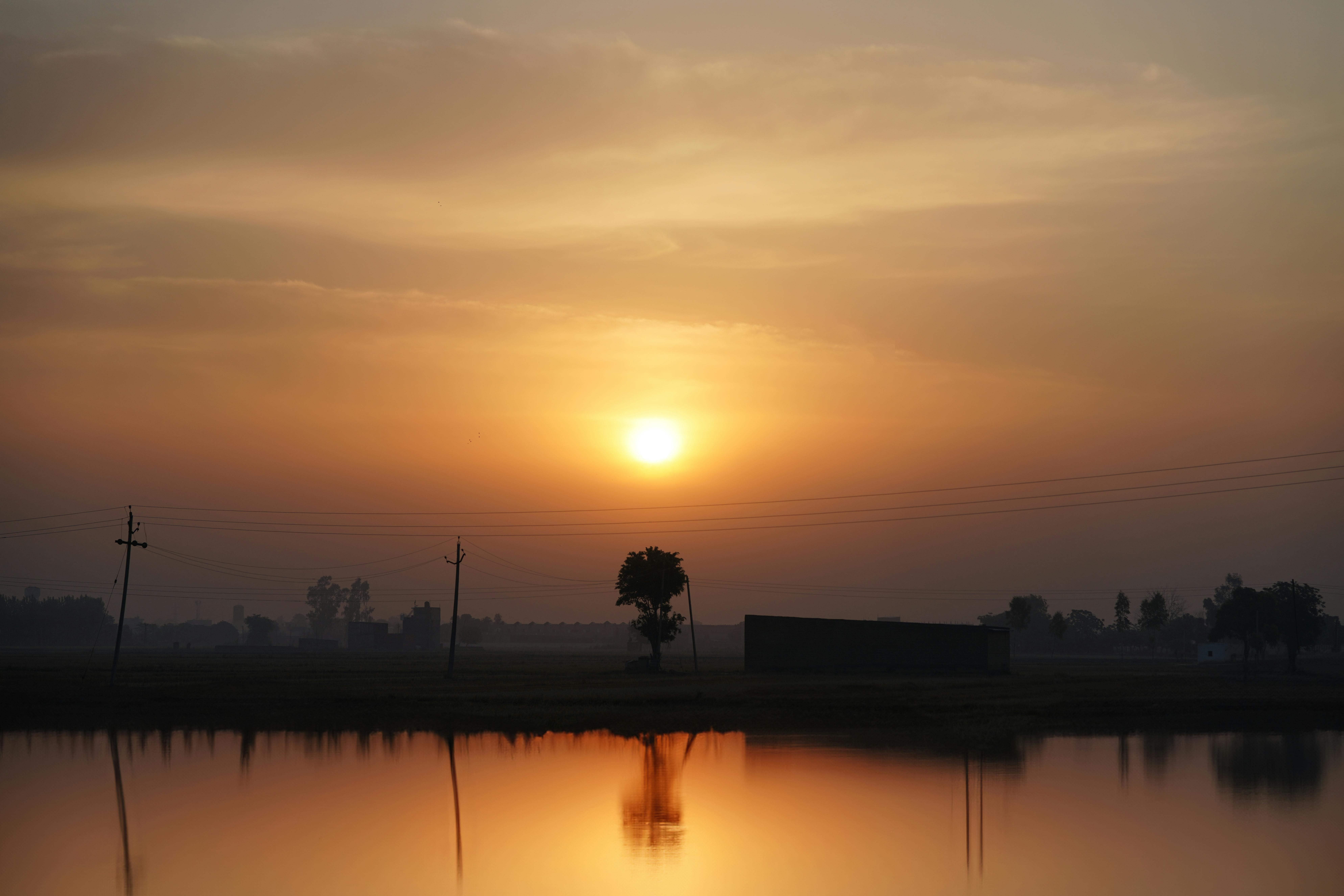 Hazy Sunset over Rural Landscape · Free Stock Photo