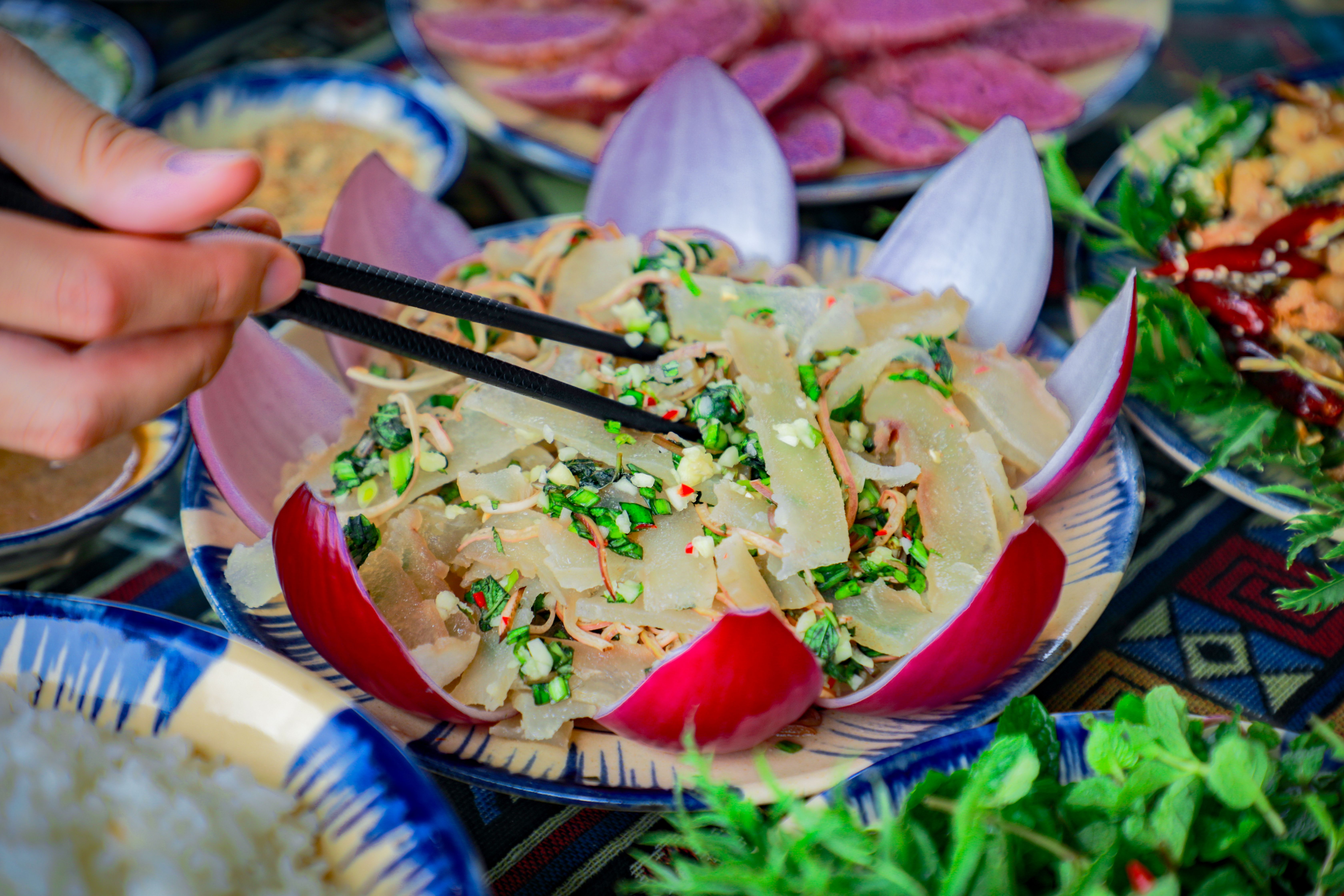 Close-up of a Person Grabbing Food from the Table with Chopsticks ...