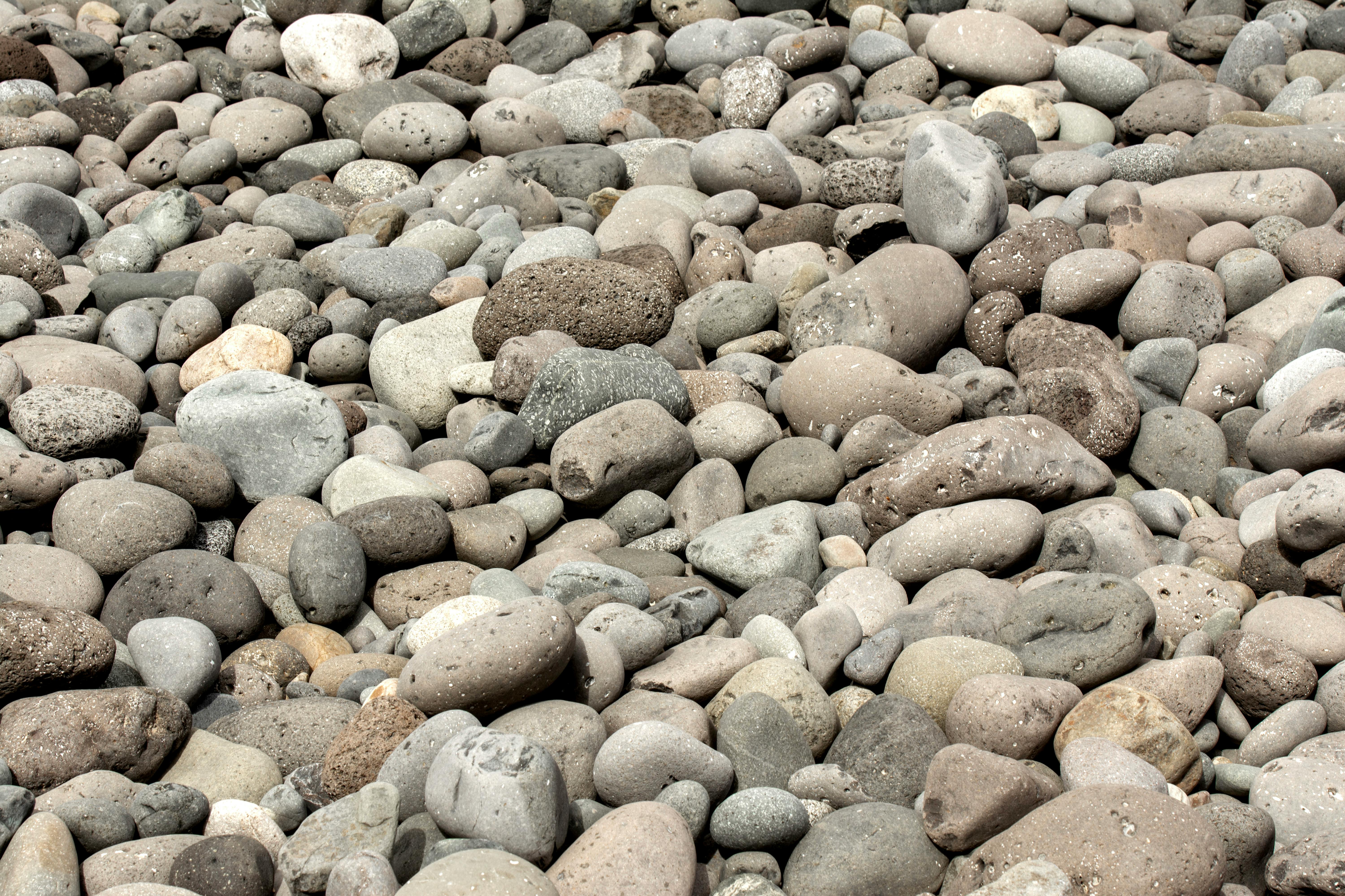 Pile of Beige Stone on Brown Wood Surface · Free Stock Photo