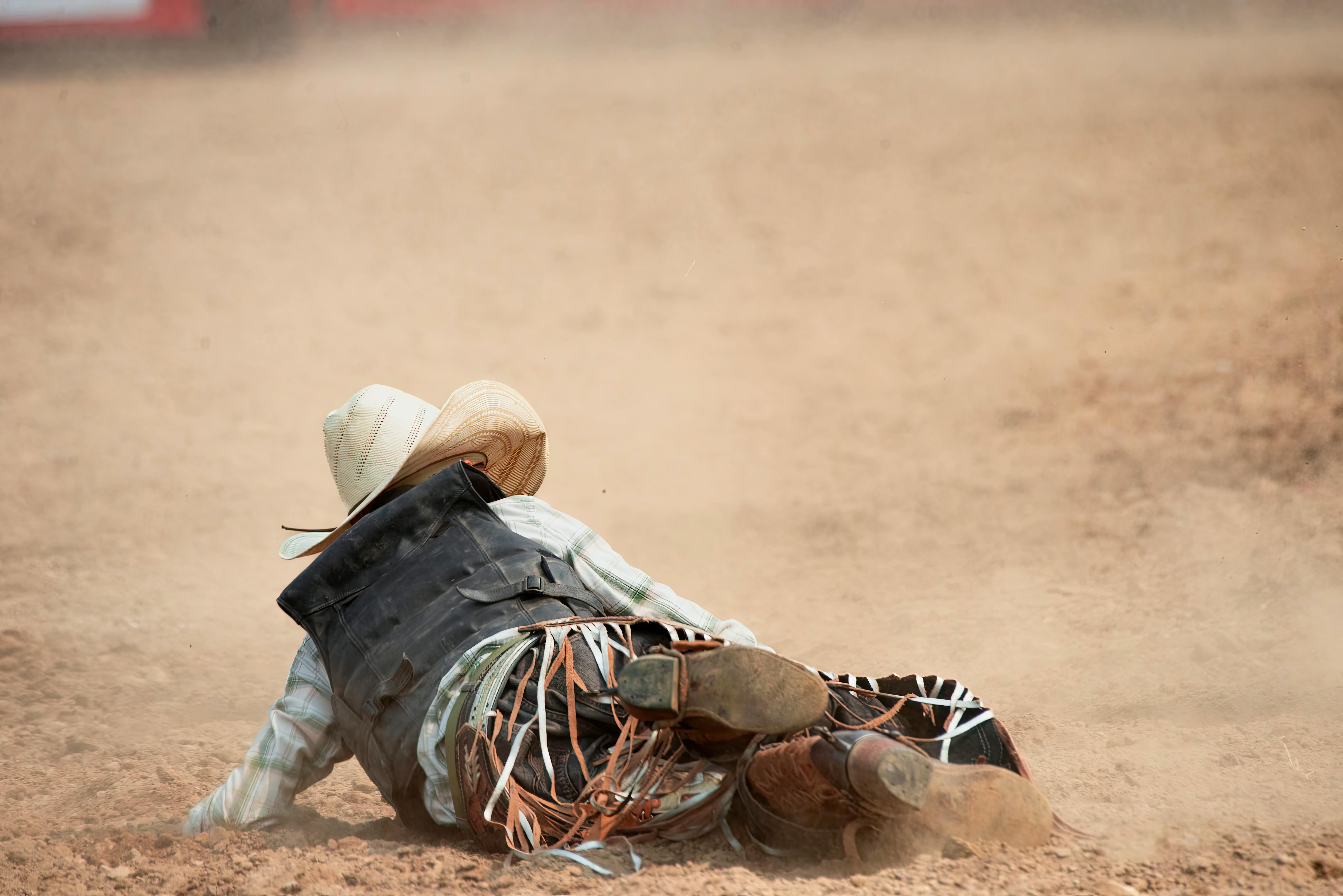 A Cowboy Lying on the Ground · Free Stock Photo