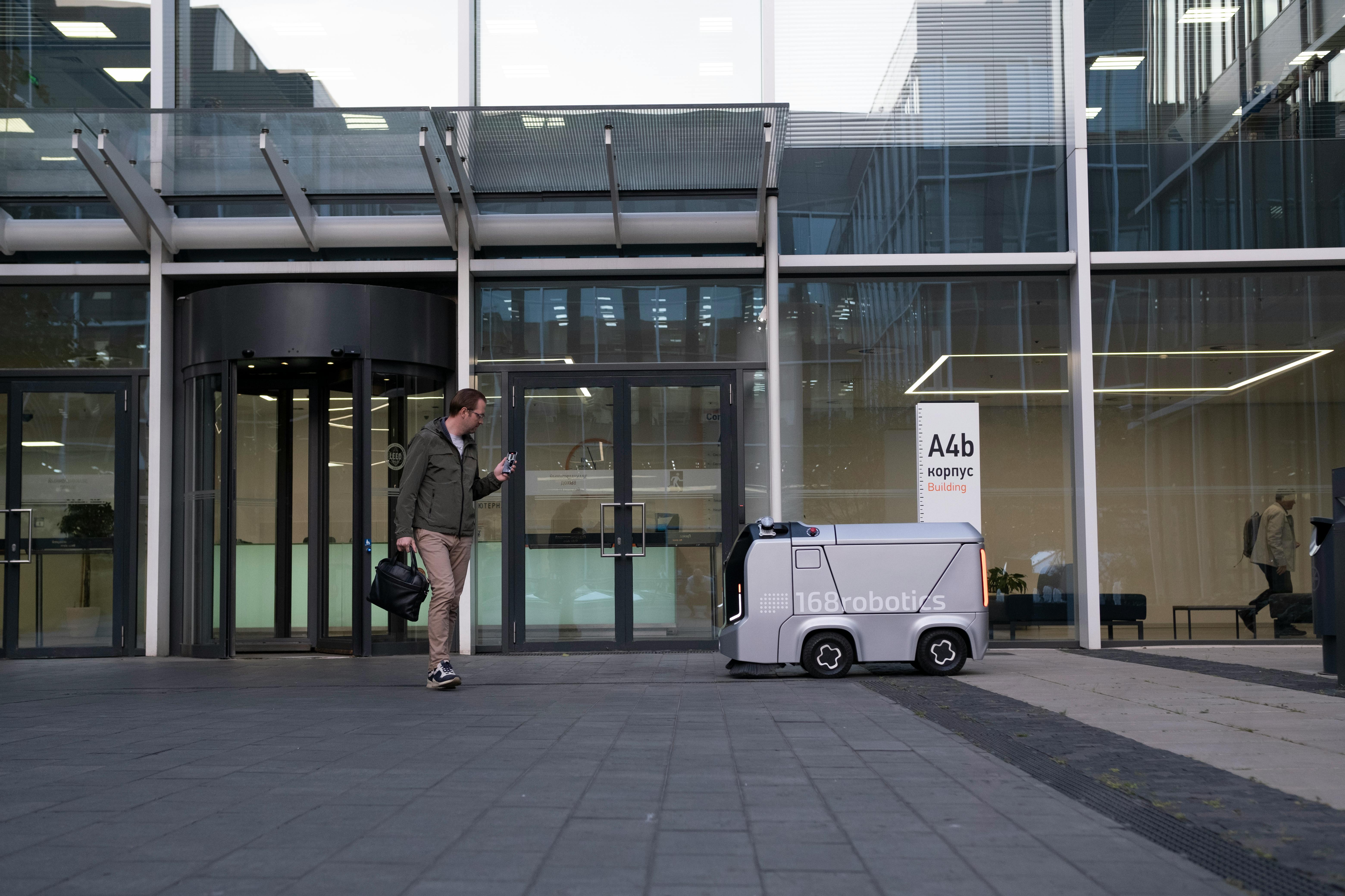 Autonomous Robot Sweeper Cleaning City Street · Free Stock Photo