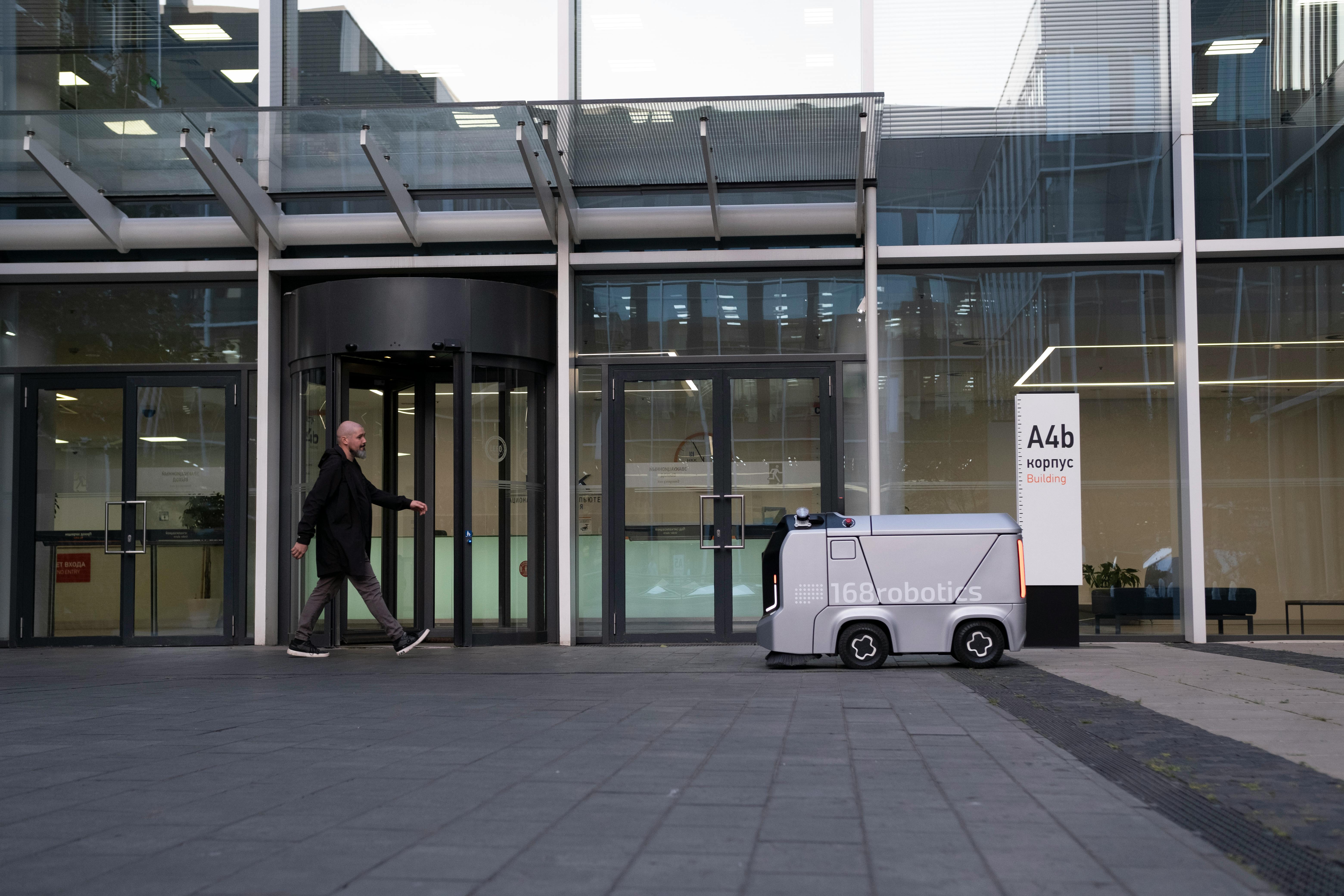 Autonomous Robot Sweeper Cleaning City Street · Free Stock Photo