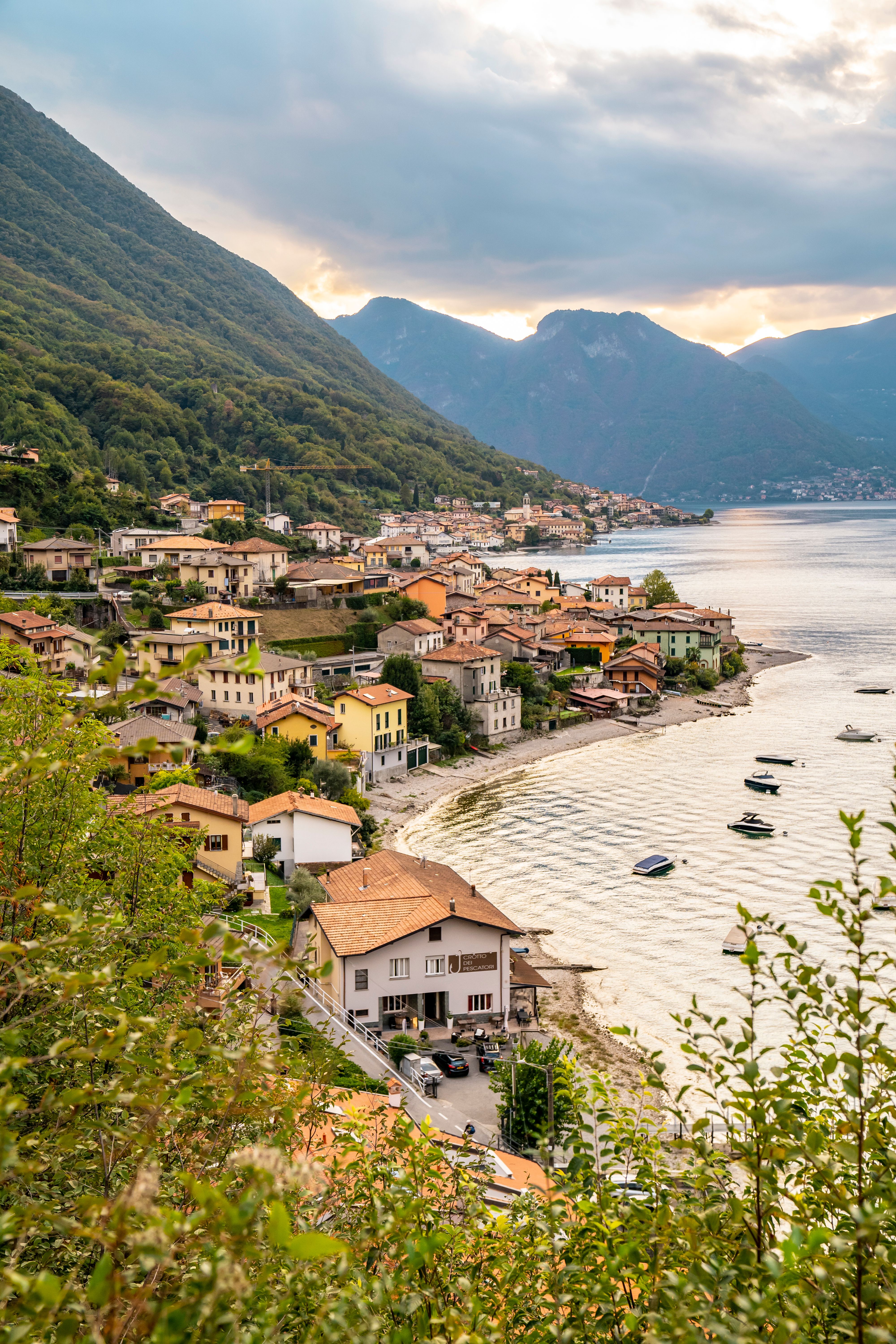 Motorboat Sailing on Lake Como Surrounded by Alps · Free Stock Photo