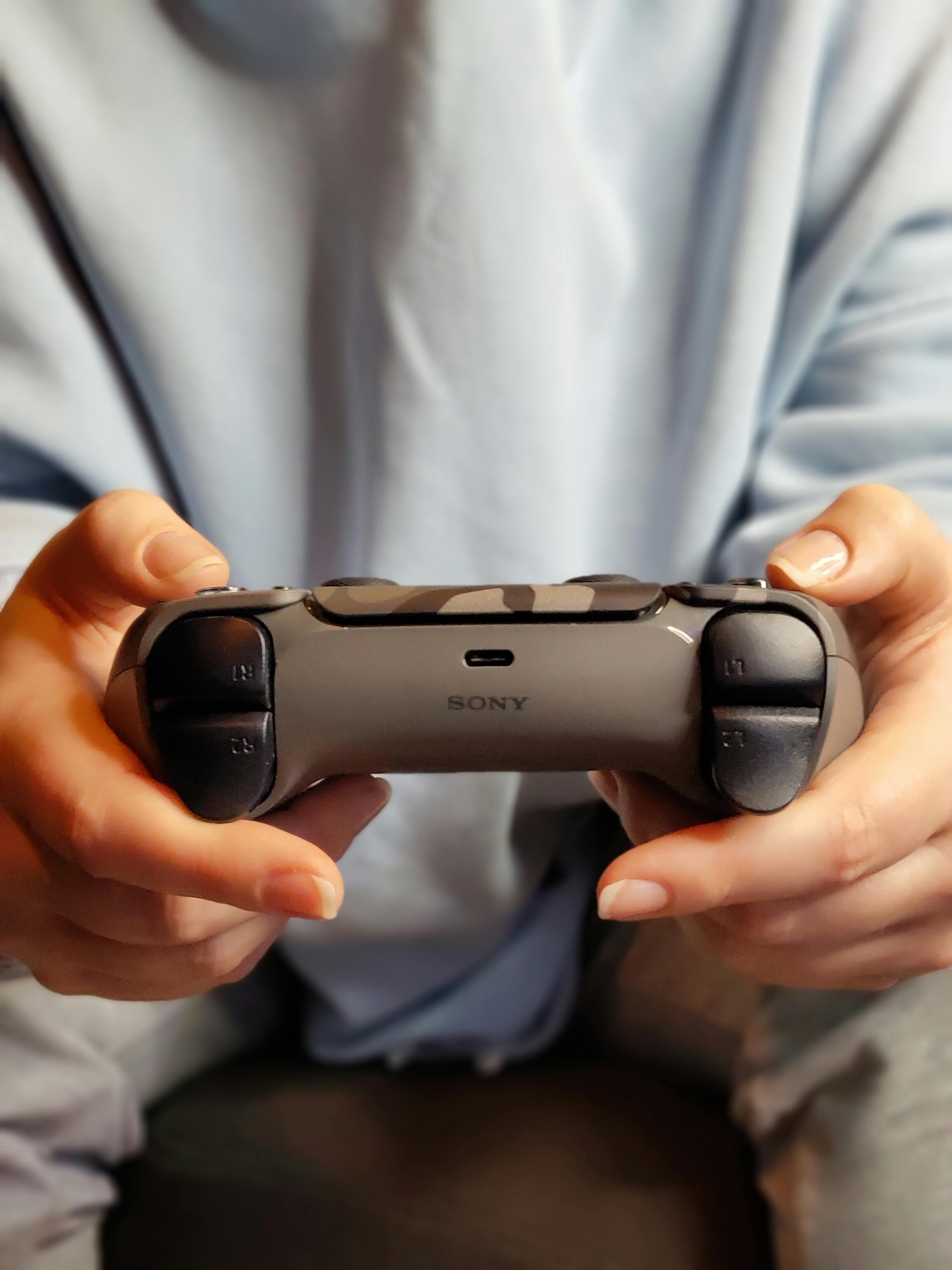 Person Holding a Sony DualSense Video Game Controller · Free Stock Photo