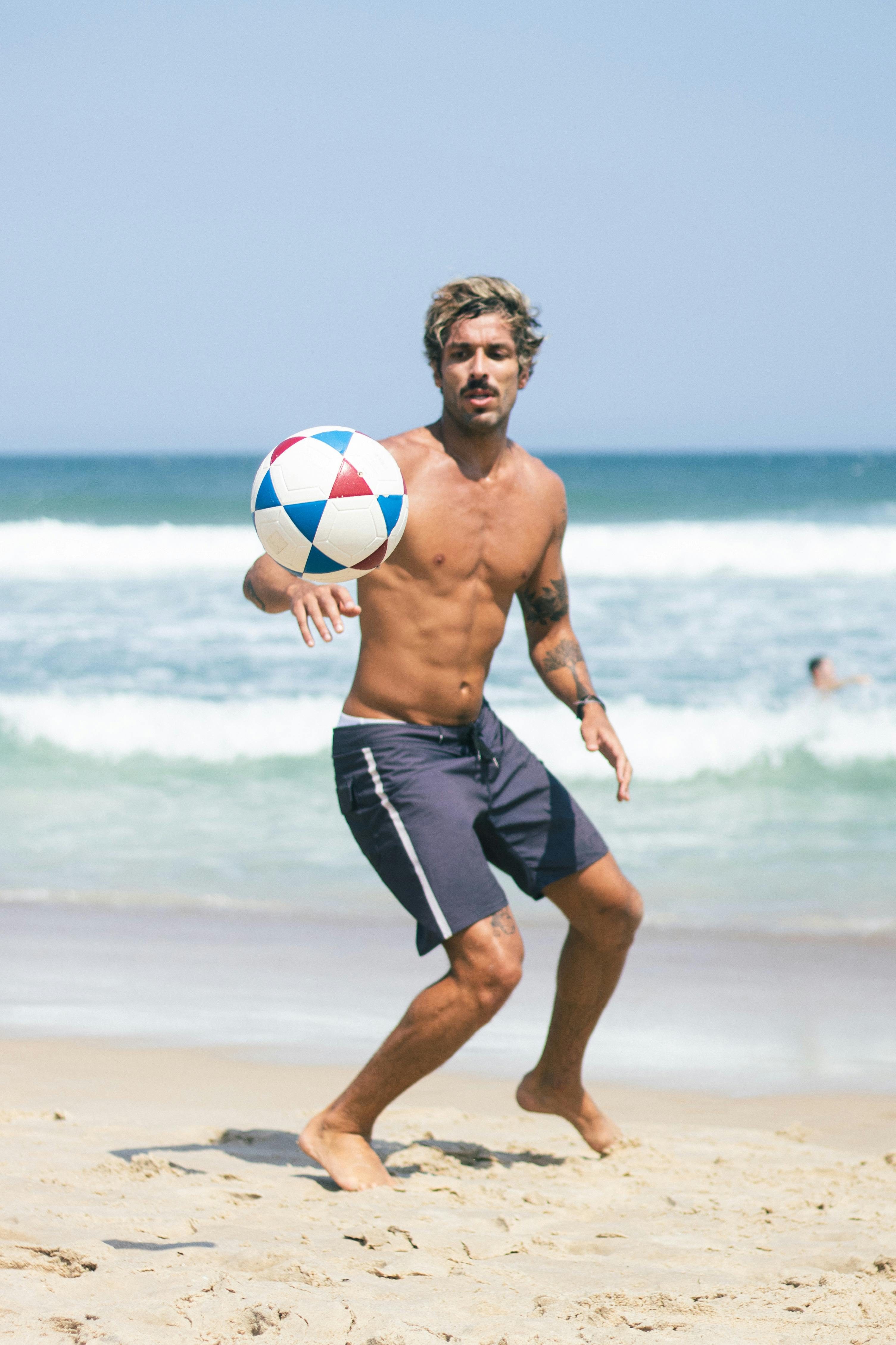Man Playing Soccer on the Beach · Free Stock Photo
