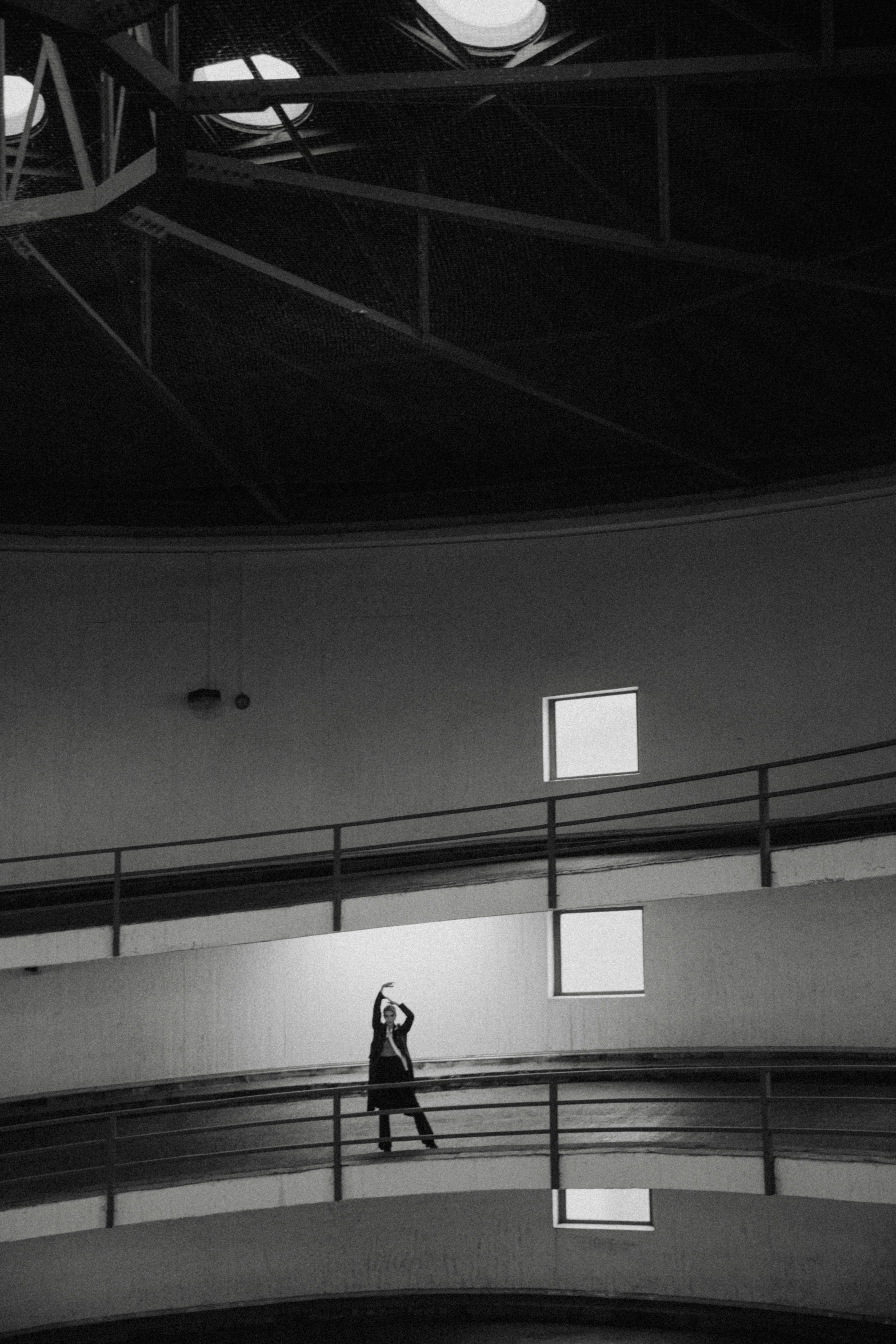 Woman in Coat Posing on Spiral Ramp · Free Stock Photo