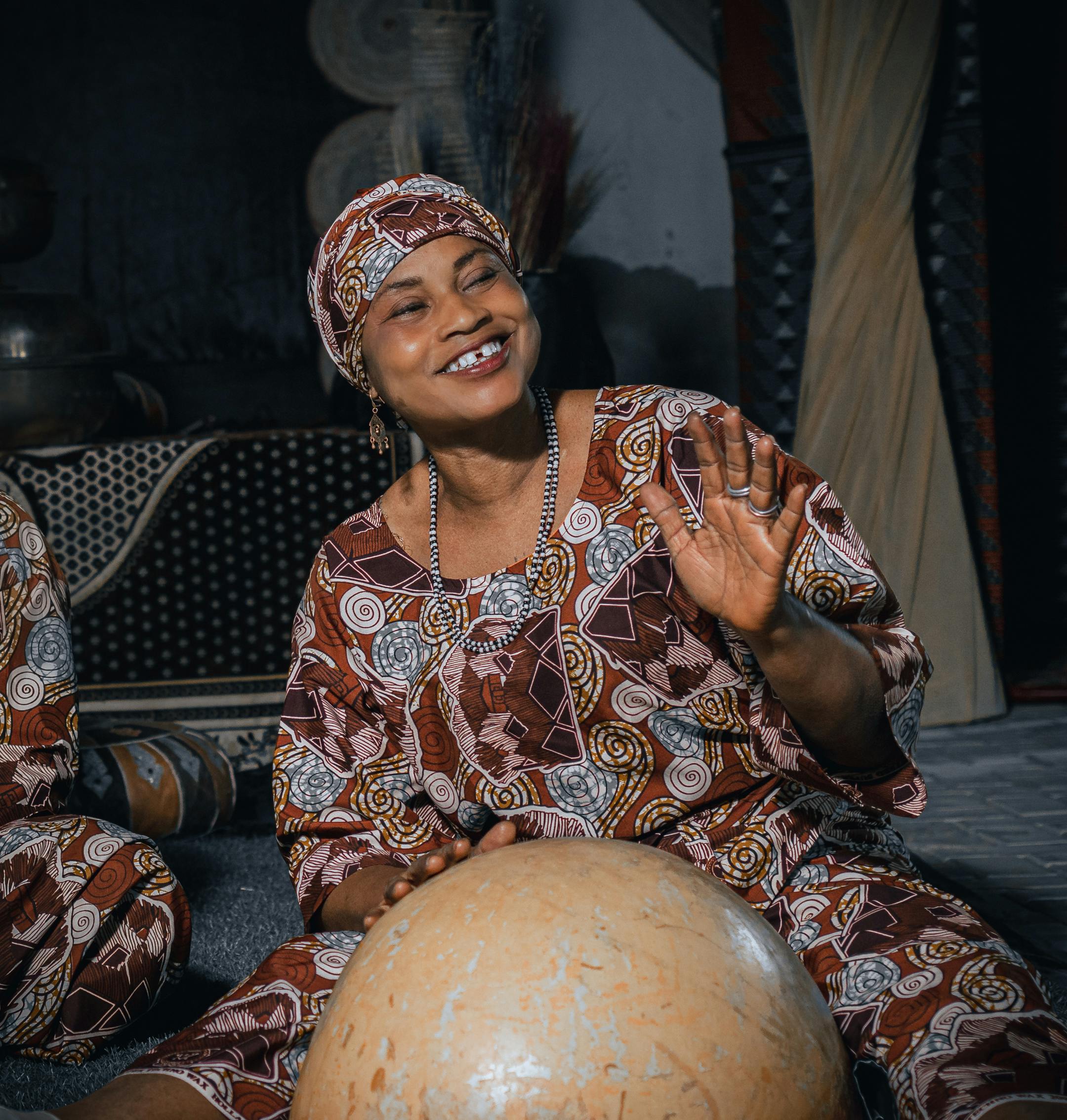 Woman in Traditional Clothing Sitting and Playing an Instrument · Free ...