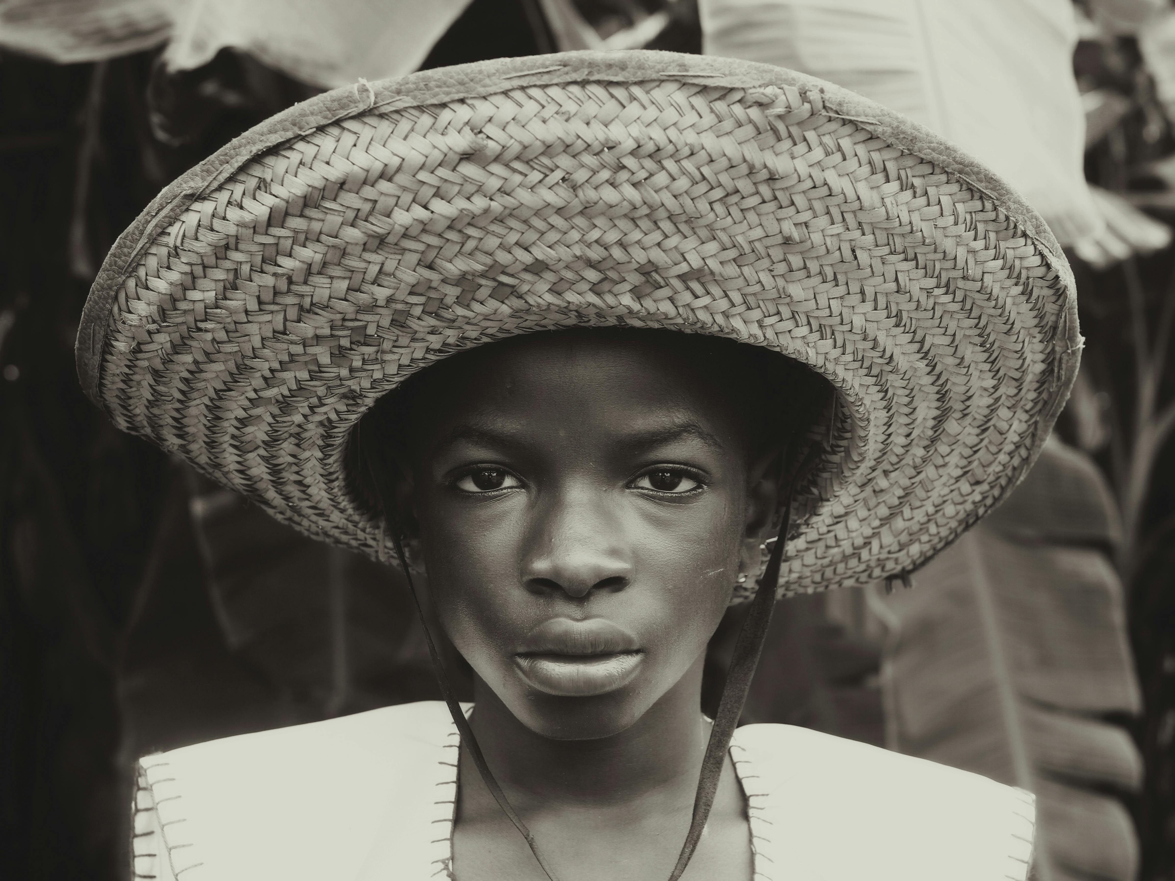 Black and White Photograph of a Girl Wearing a Straw Hat · Free Stock Photo