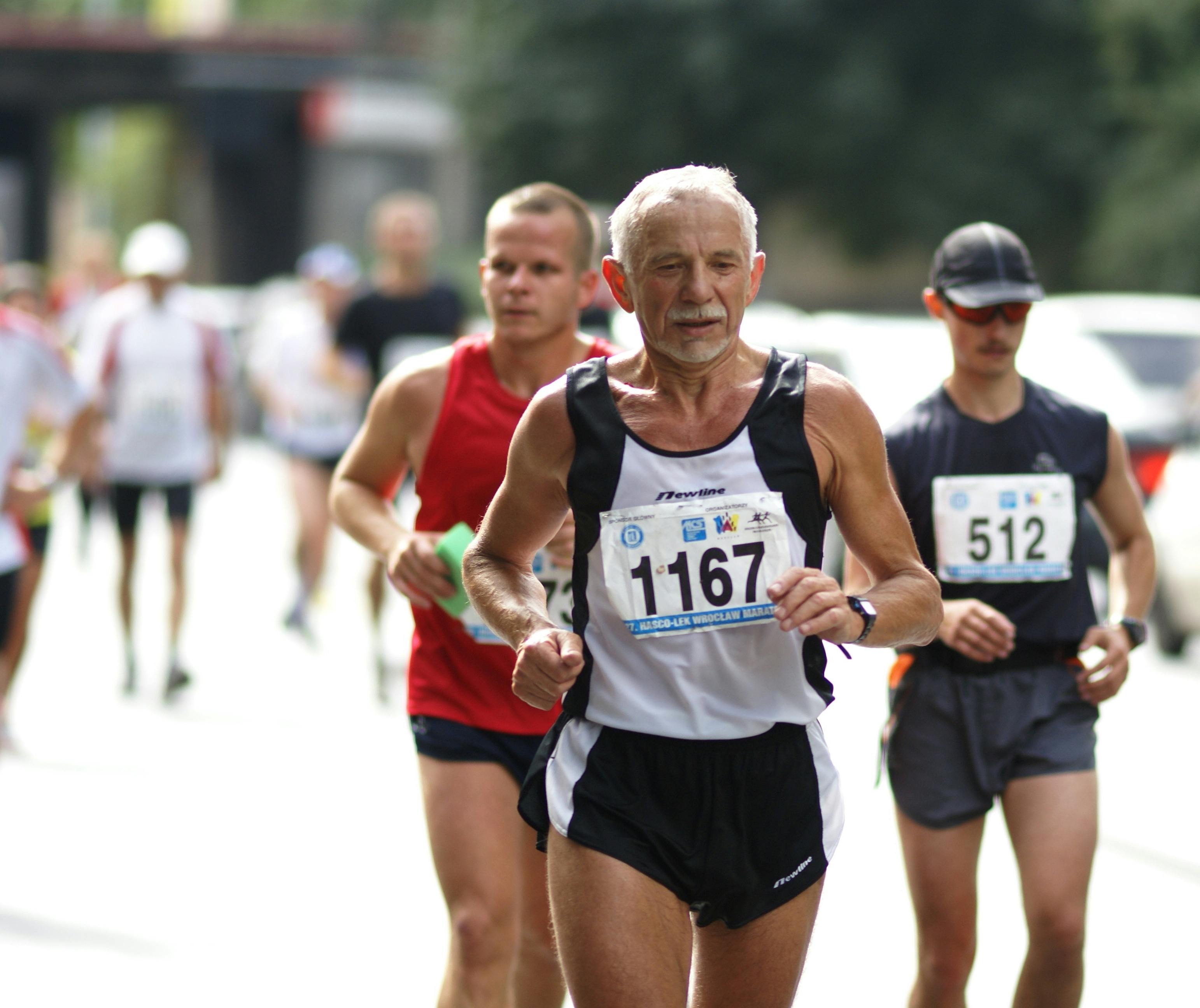 An older man running in a marathon · Free Stock Photo