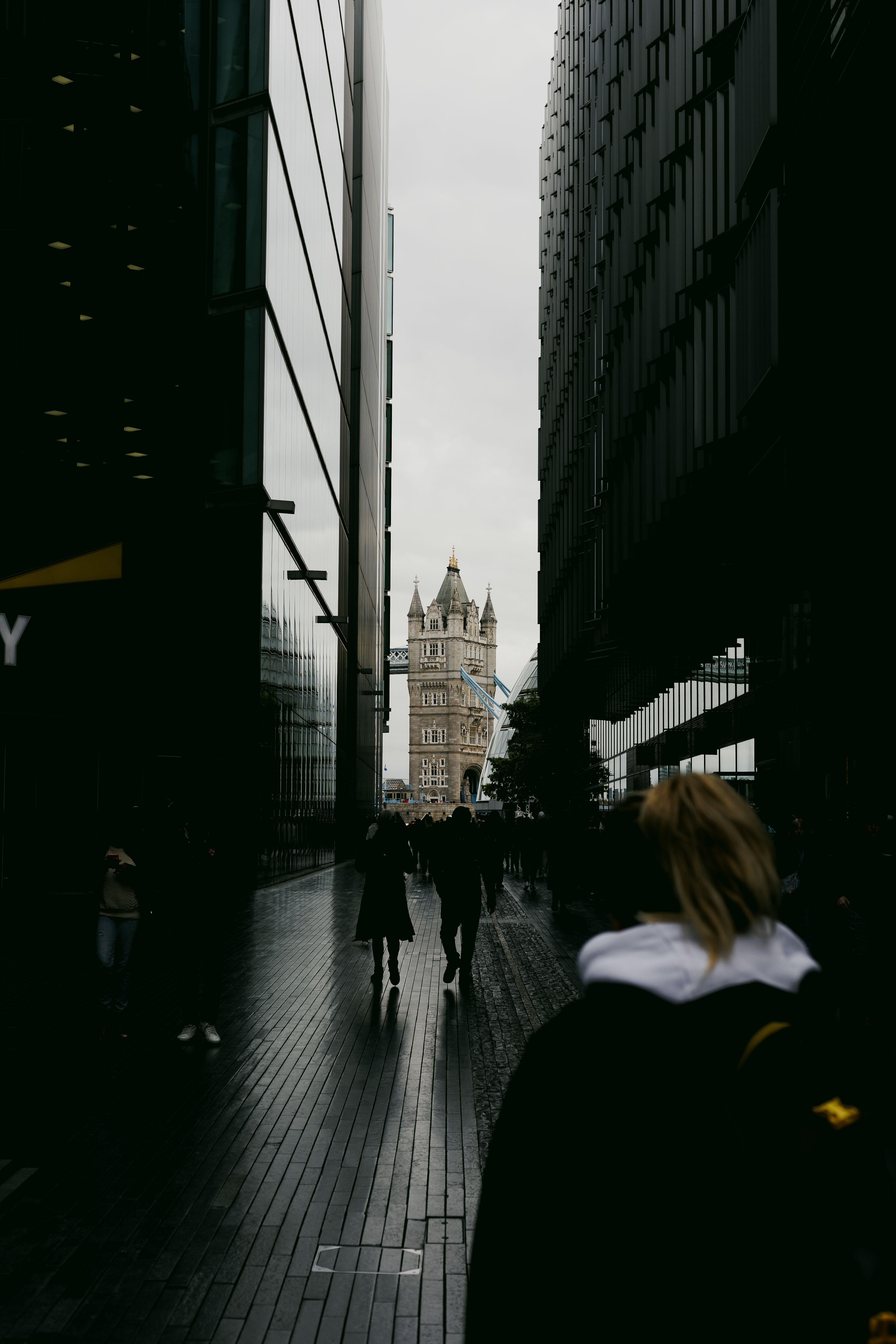View of the Tower Bridge from a Street between Buildings in London ...