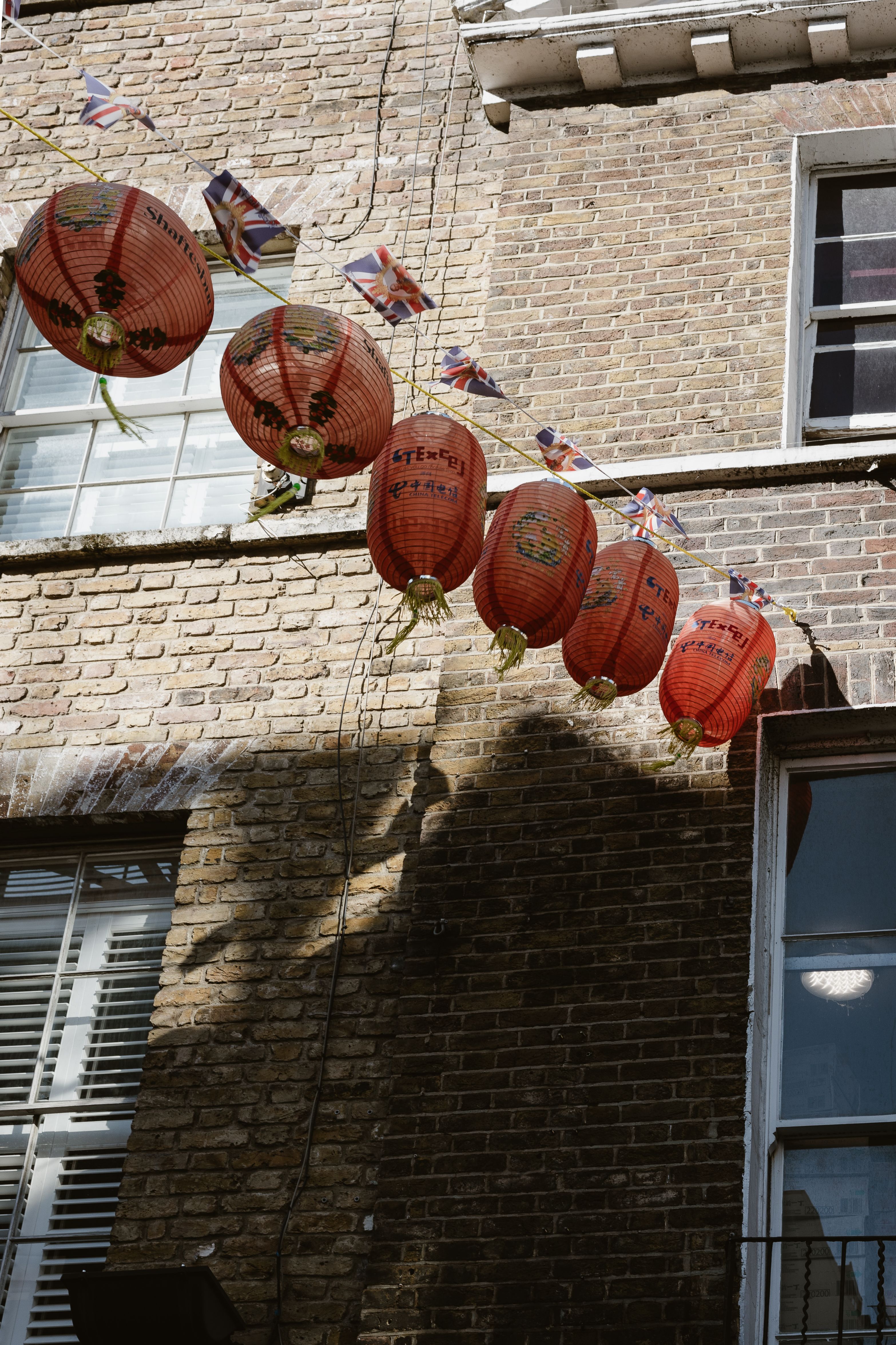 Red Paper Chinese Lanterns and Small Union Jack Flags Hanging Above the ...