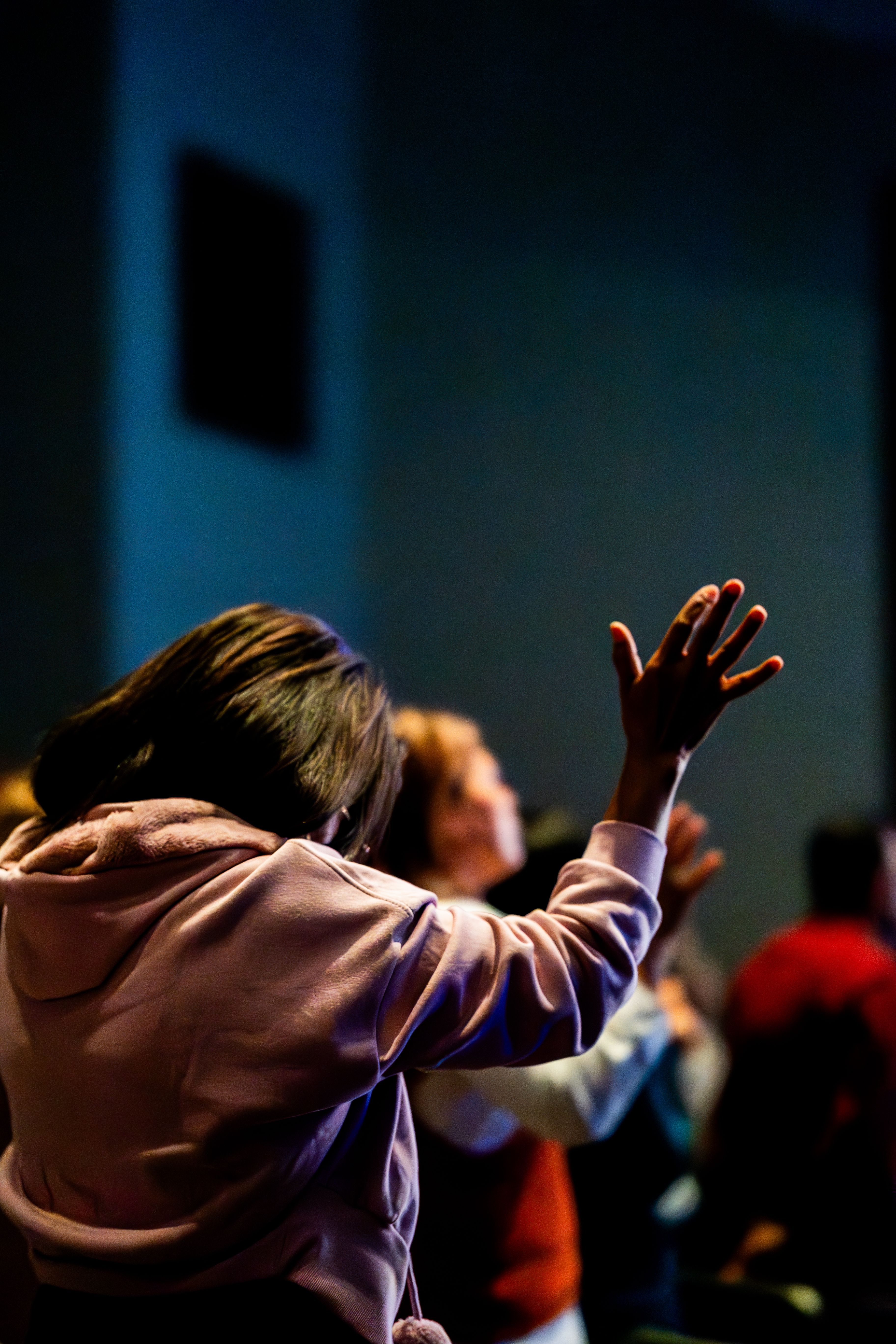 Photo of a Man Raising his Hands towards a Stage with a Cross · Free ...