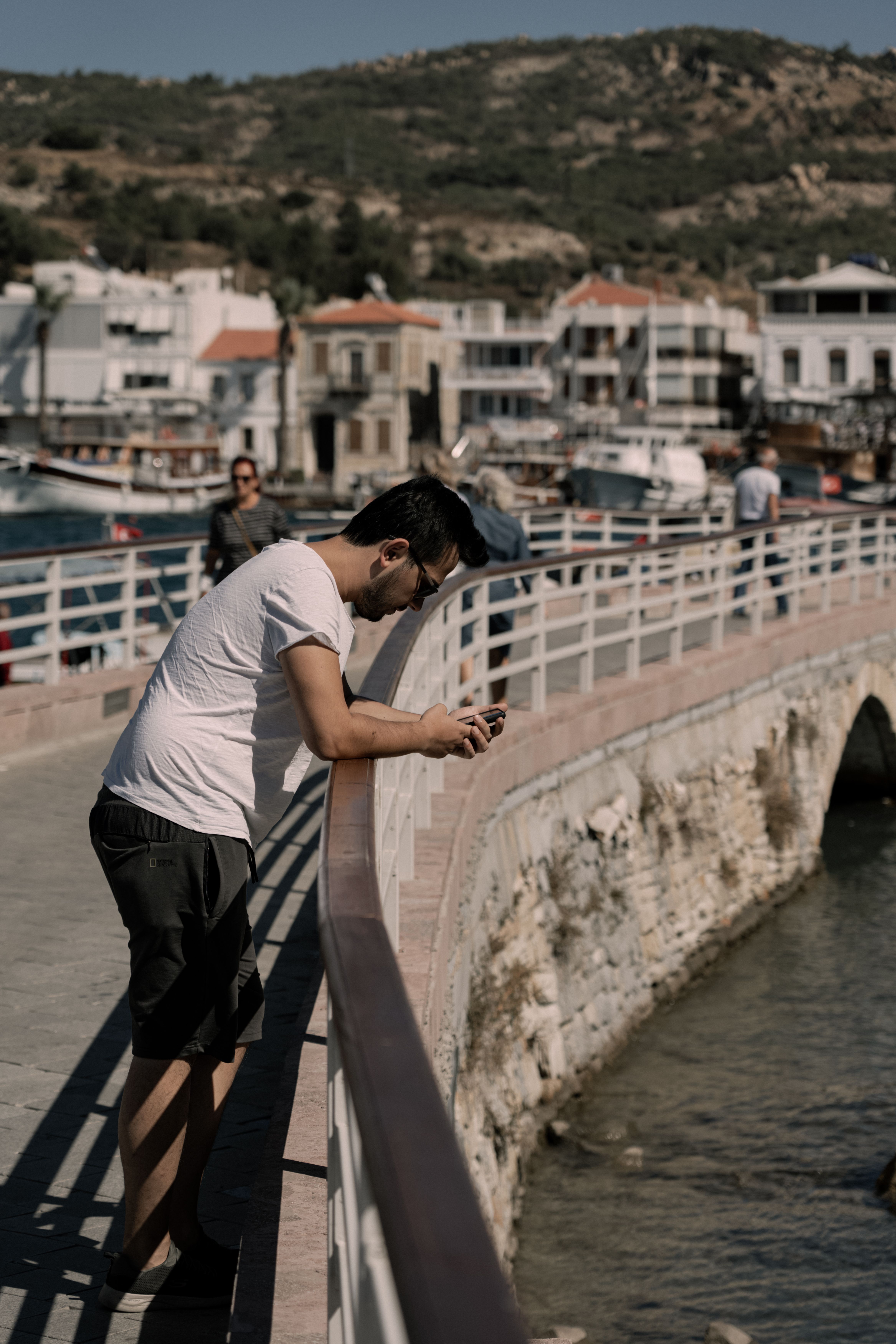 Man Standing on Bridge in Town · Free Stock Photo