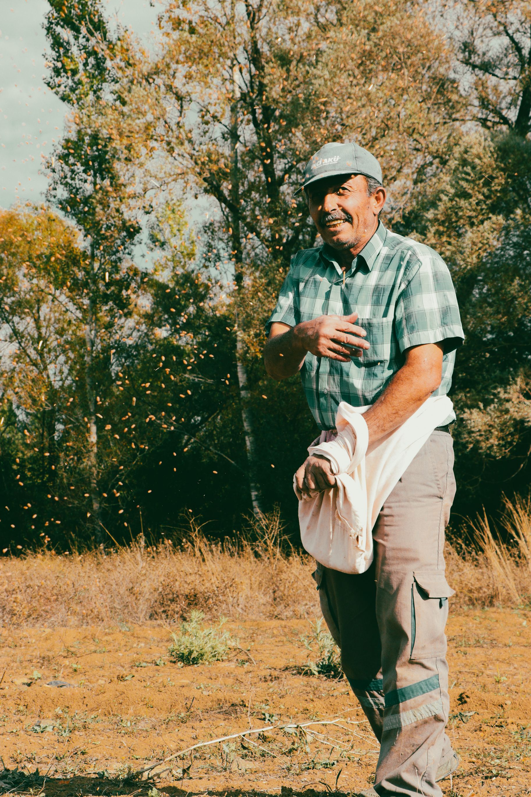 Farmer Walking in the Field Scattering Seeds · Free Stock Photo