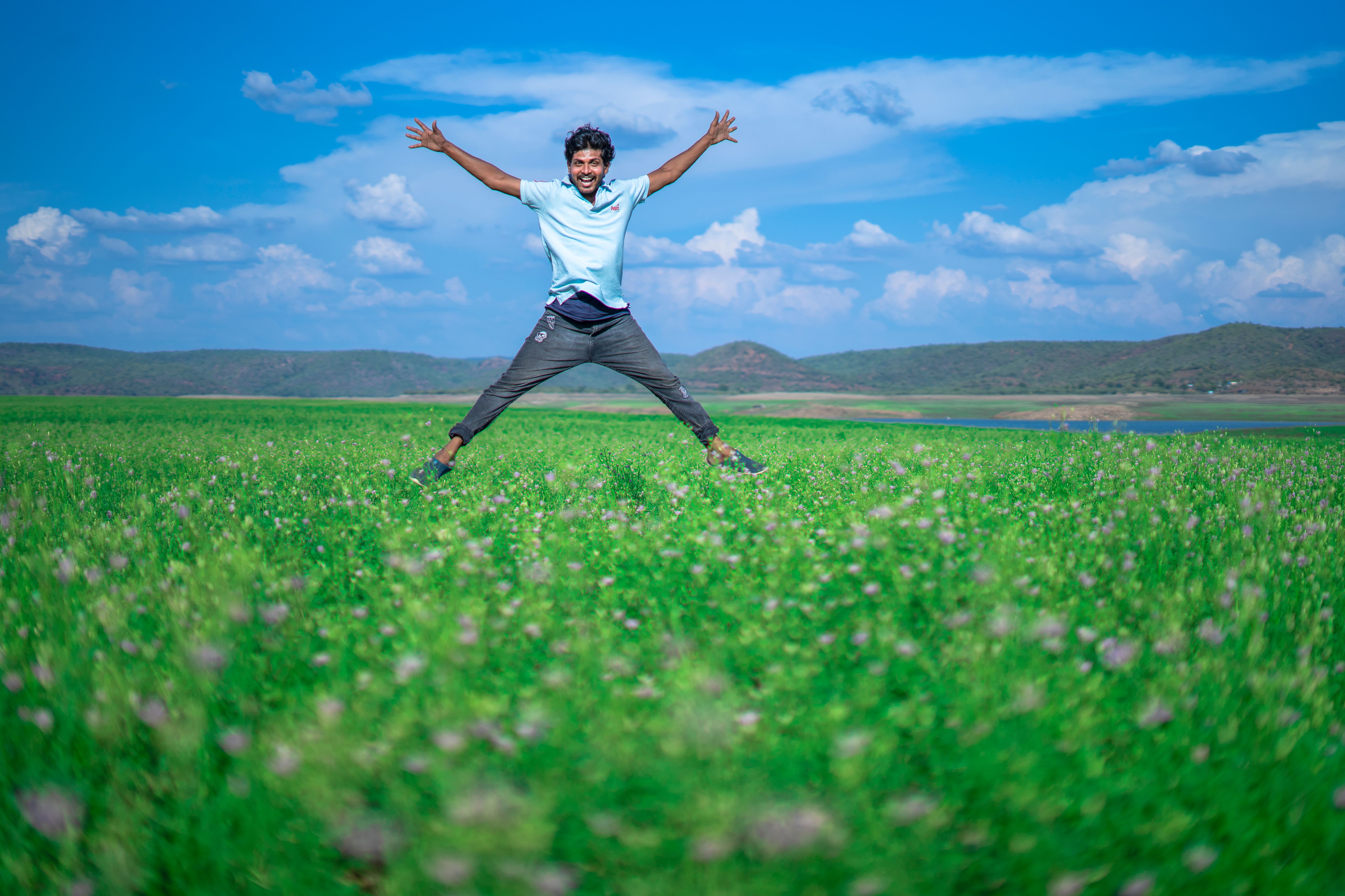 Man Jumping on the Meadow in Midair · Free Stock Photo