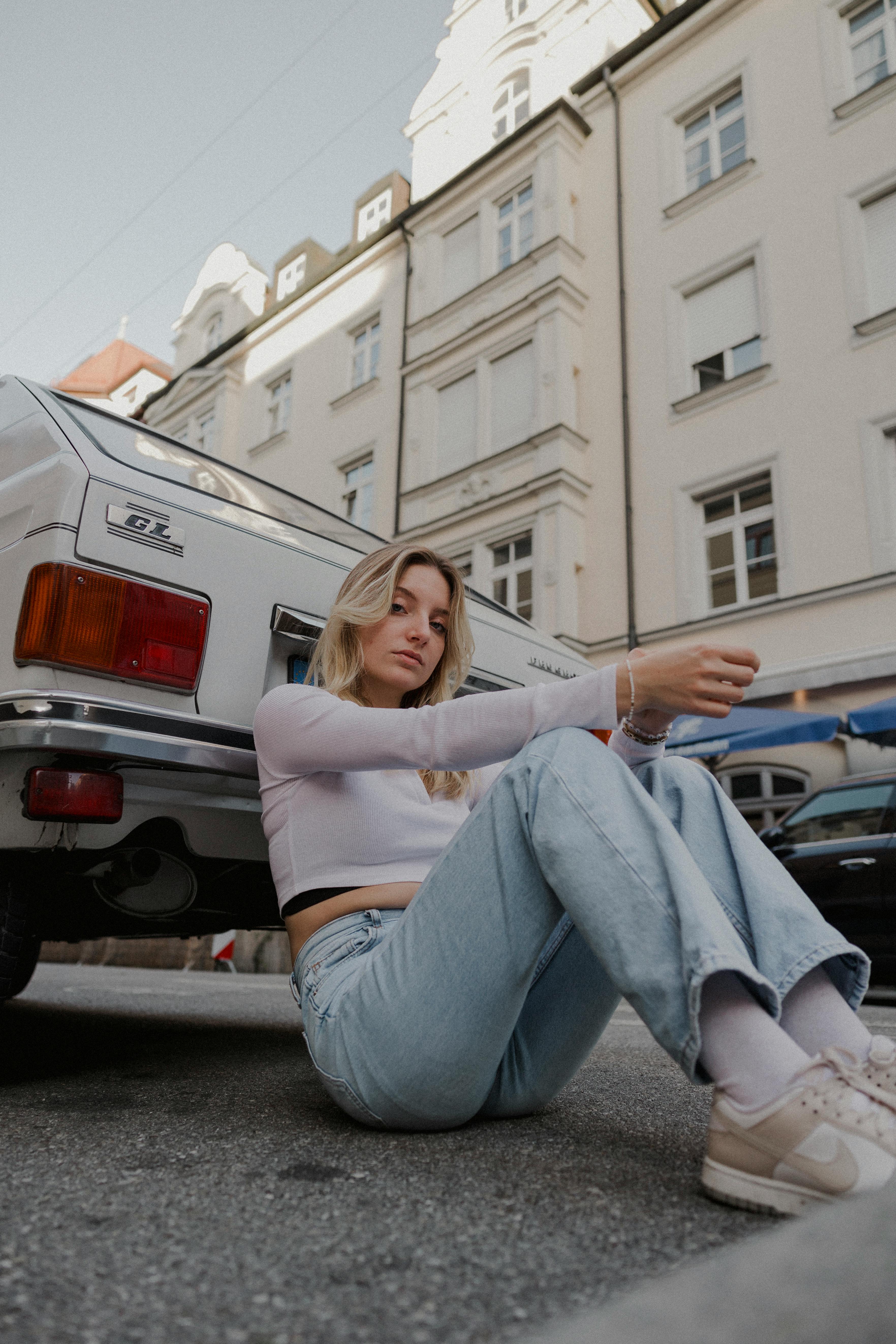 Sitting on Street Woman Leaning her Back on Car Rear Bumper · Free ...