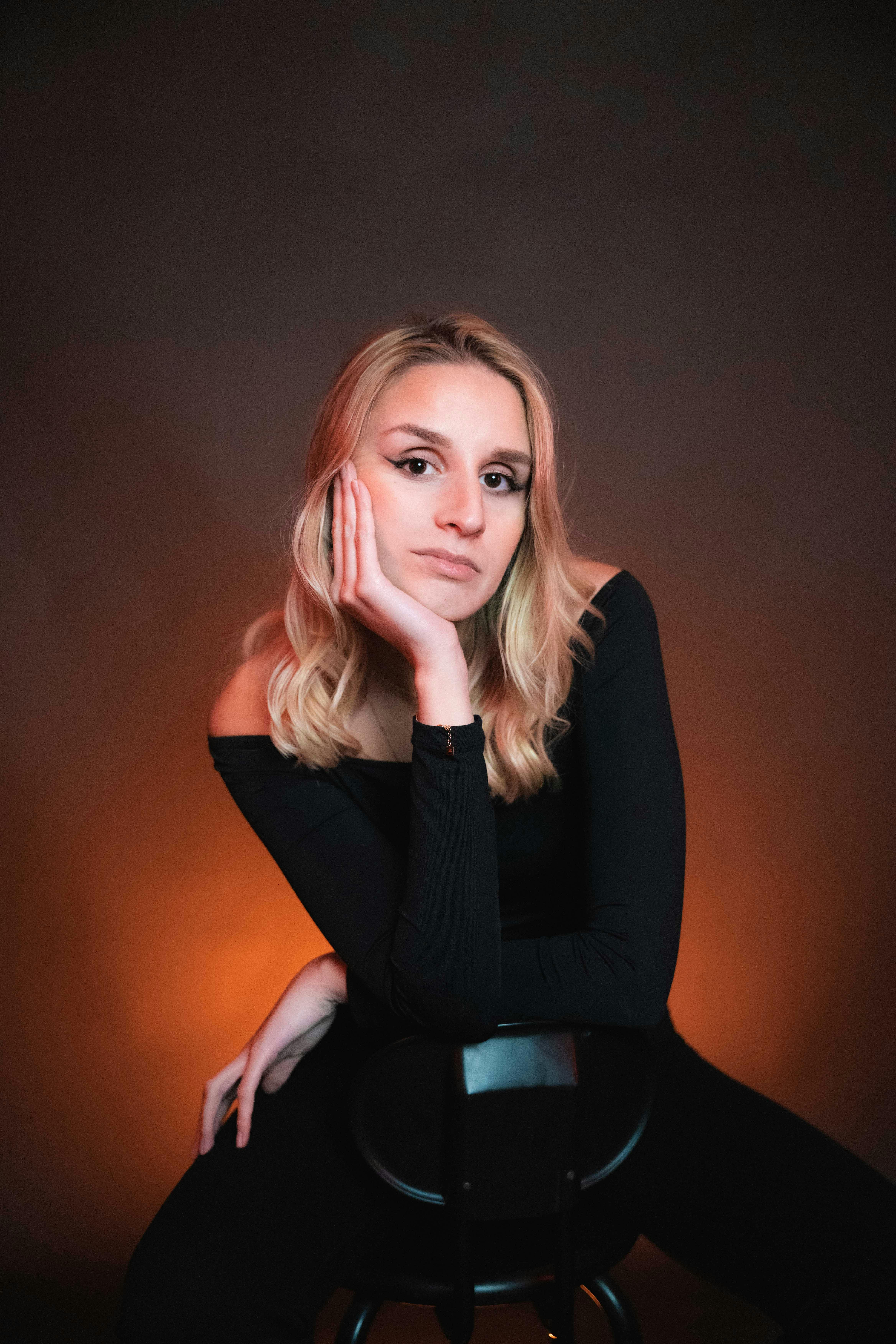 Young Woman Sitting Astride on a Stool · Free Stock Photo