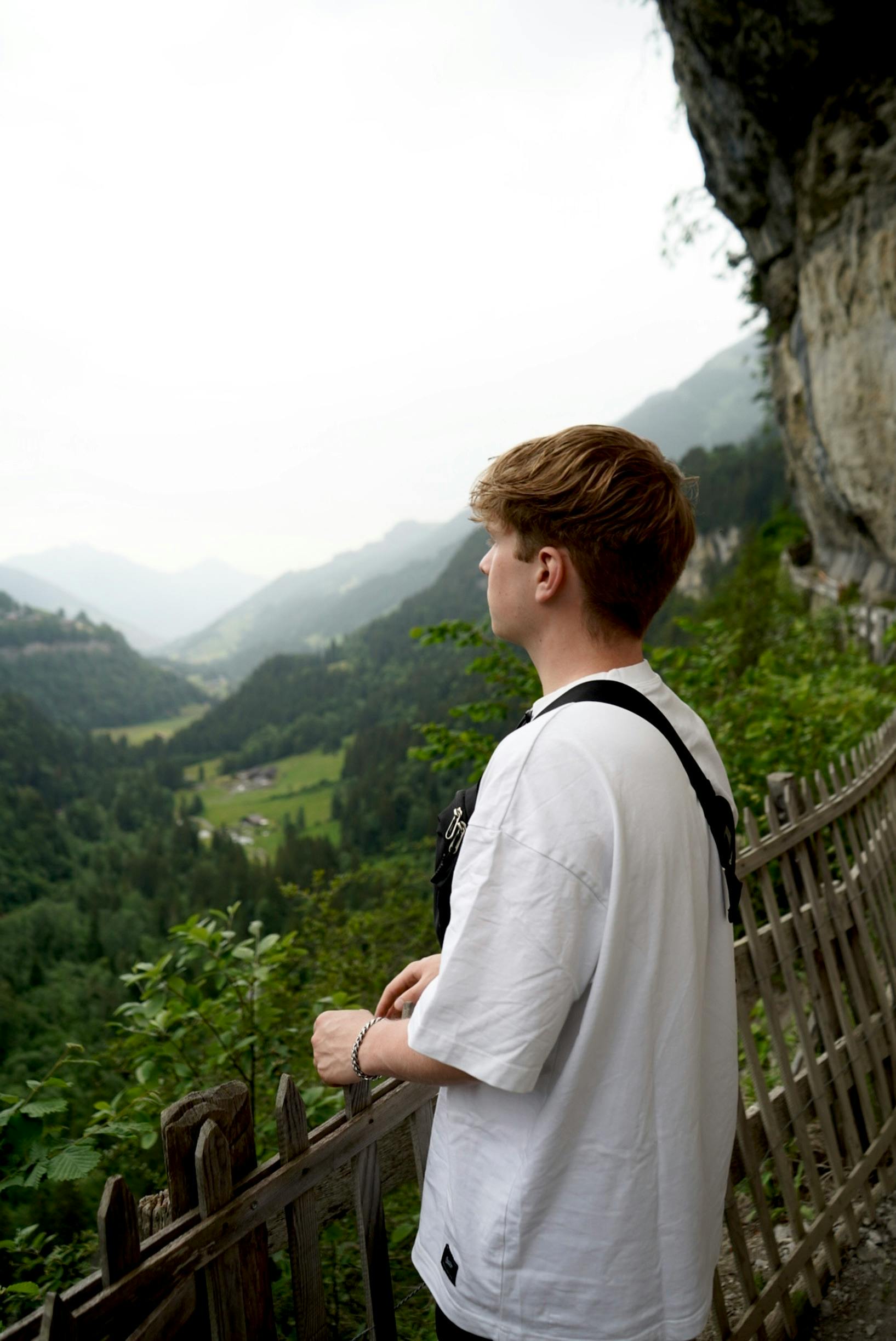 Side View Photo of Woman Sitting on Ground Overlooking a Hill · Free ...