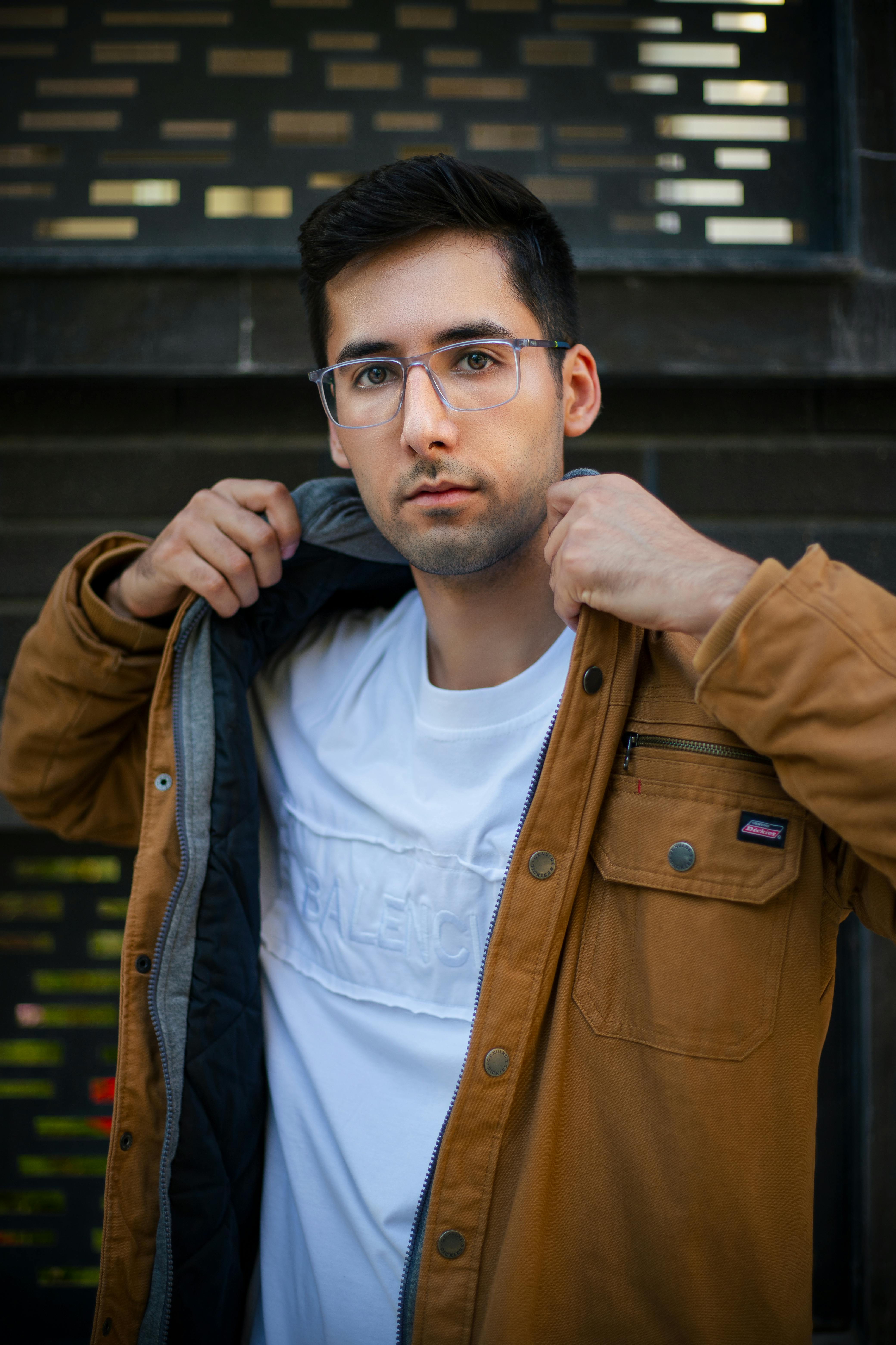 Young Man Putting on a Jacket · Free Stock Photo