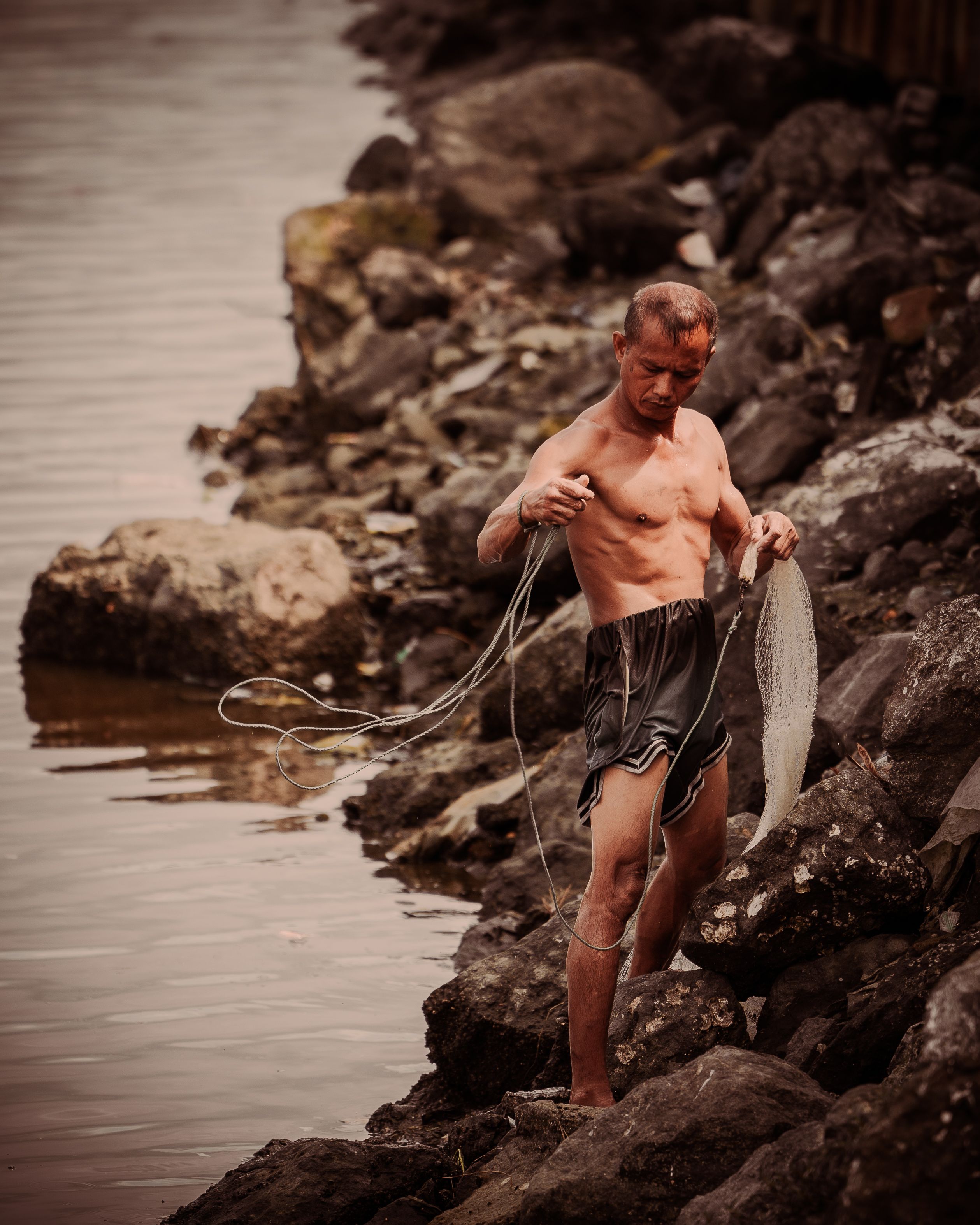 Man with Fishing Nets in his Hands Standing on the Shore · Free Stock Photo