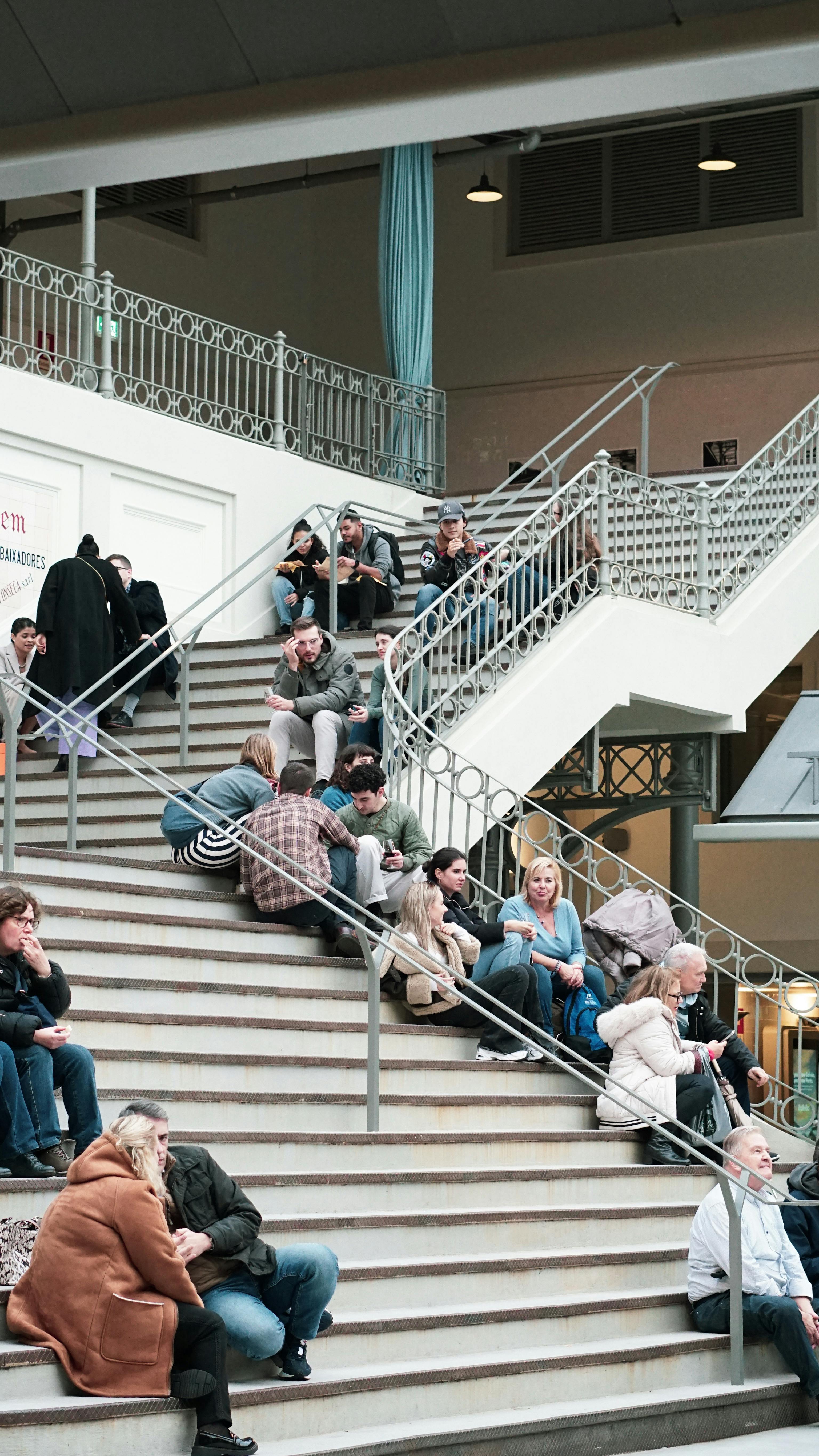 Group of People Sitting on a Staircase · Free Stock Photo