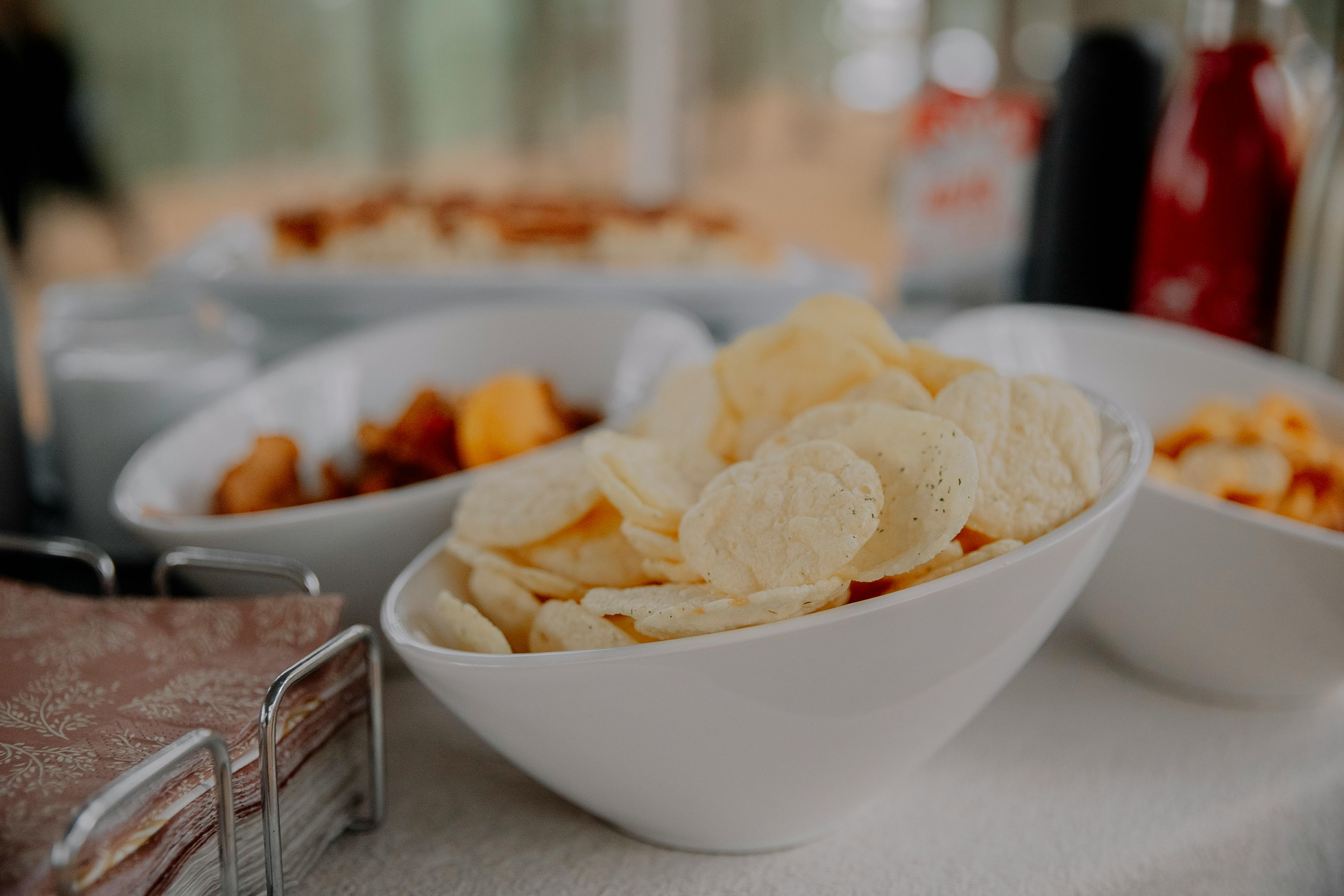 Woman Eating Snacks at Table · Free Stock Photo