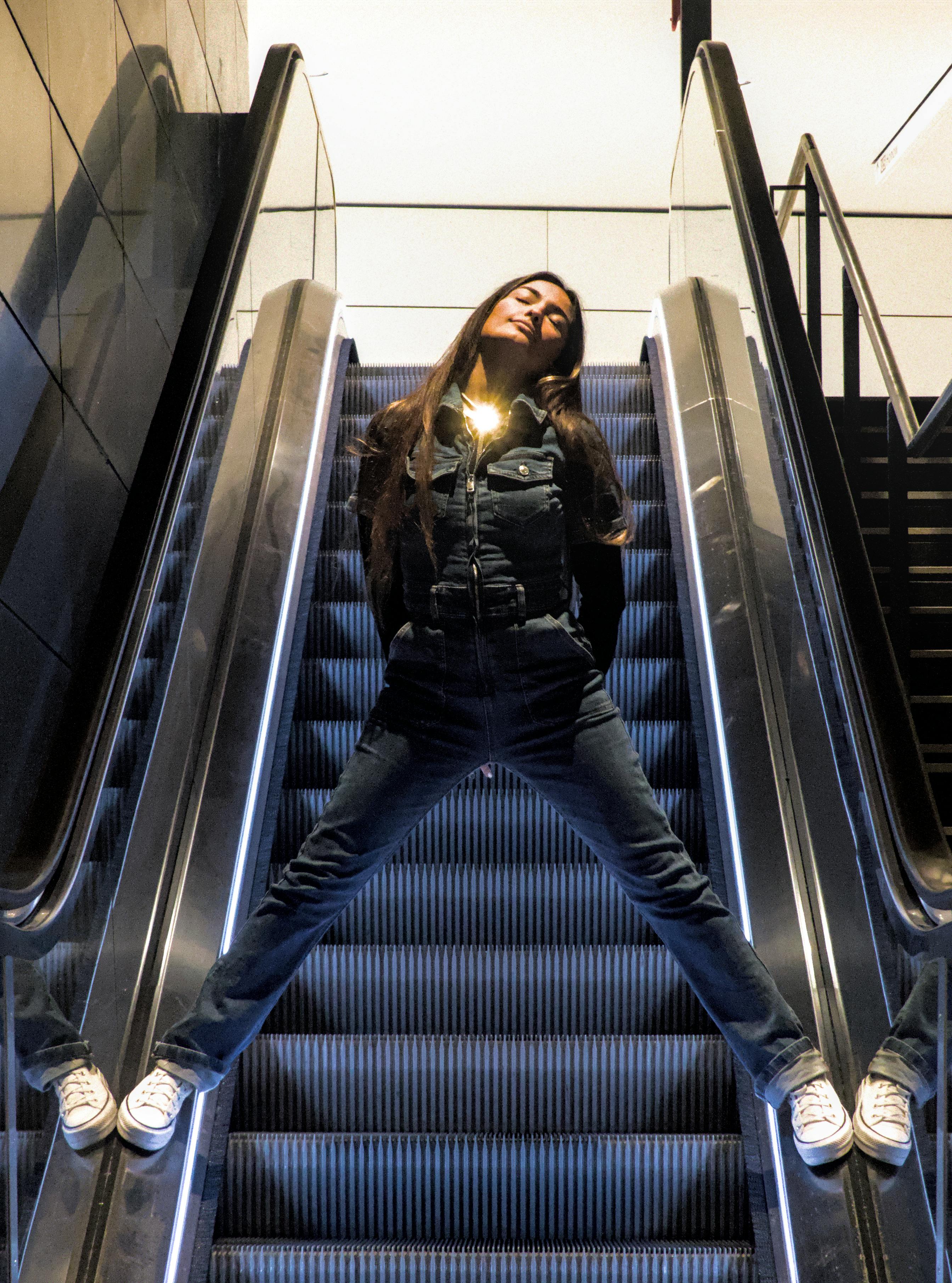 Woman Posing on Escalator Handrails · Free Stock Photo Woman Posing on Escalator Handrails · Free Stock Photo