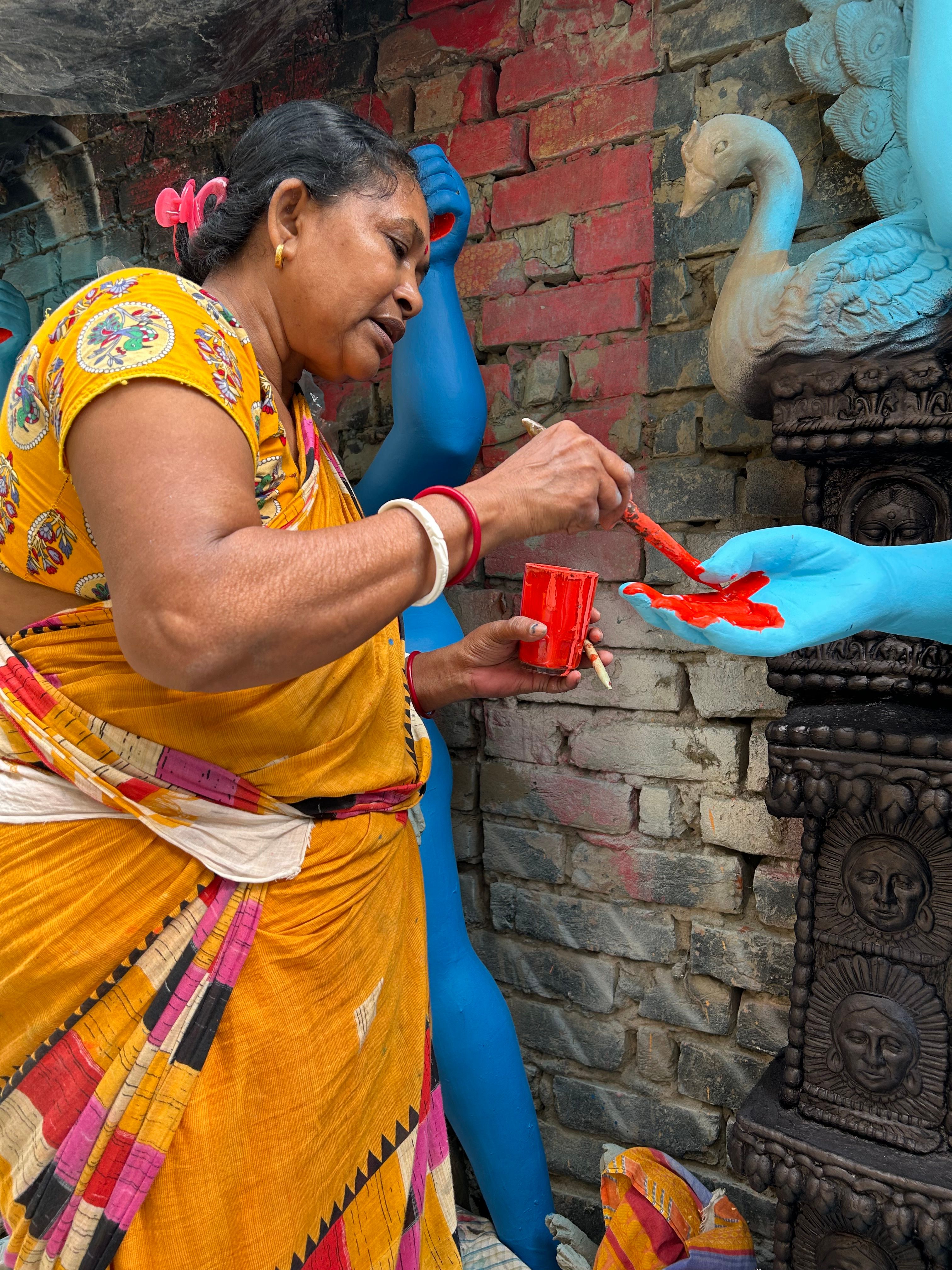 Woman in Traditional Clothing Painting Statue Hand · Free Stock Photo
