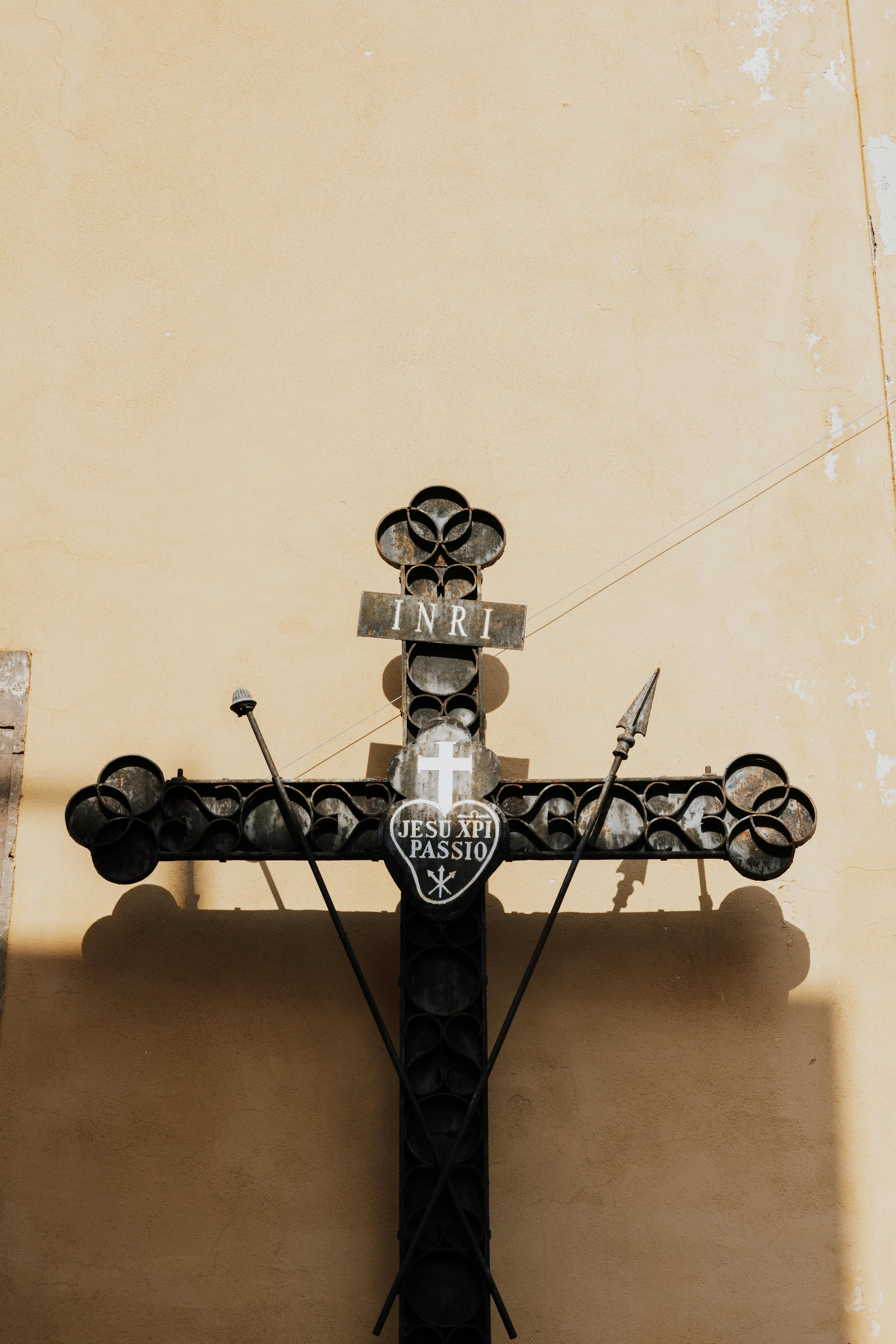 Metal Cross on Yellow Background · Free Stock Photo