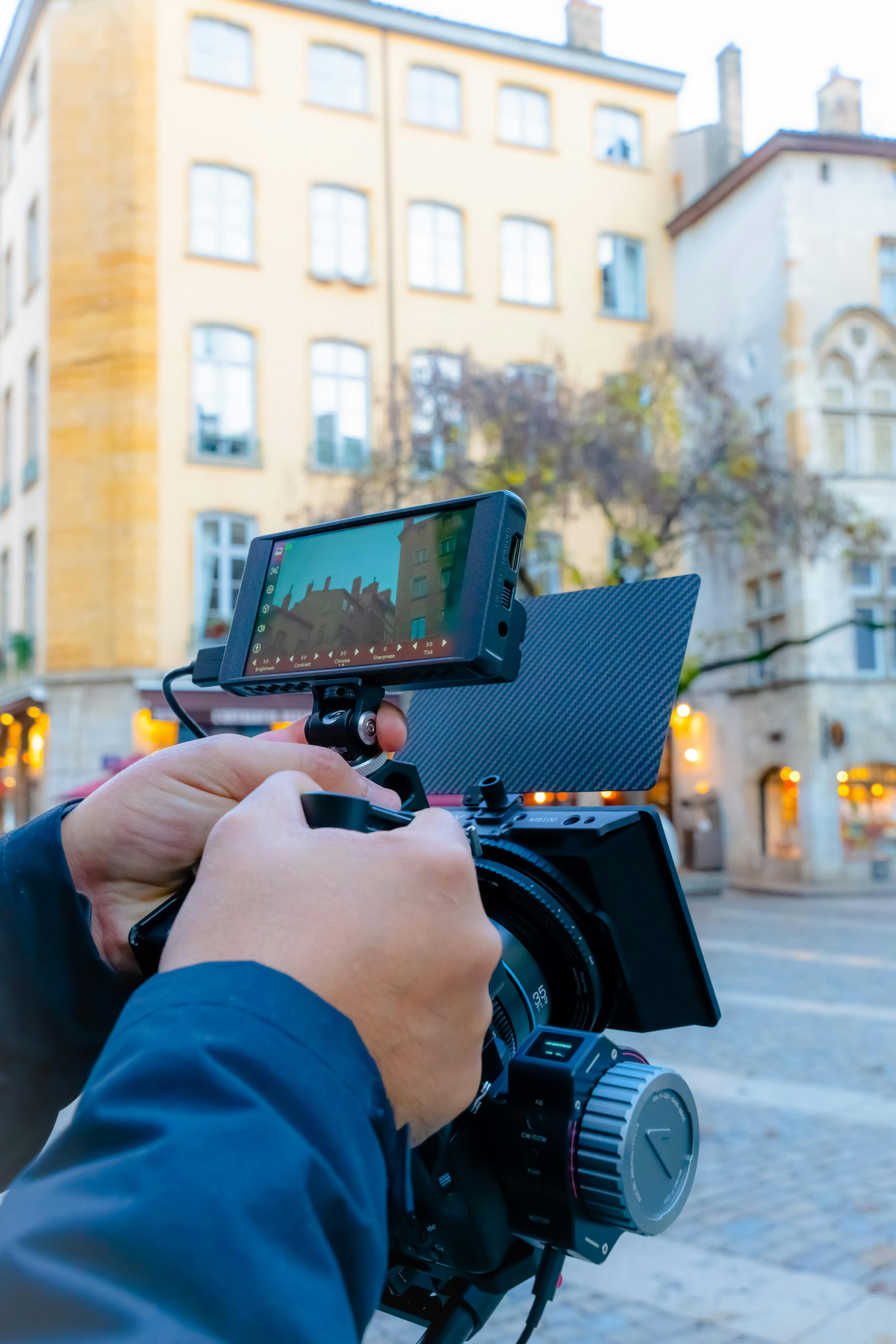 Woman Holding a Black Video Camera · Free Stock Photo