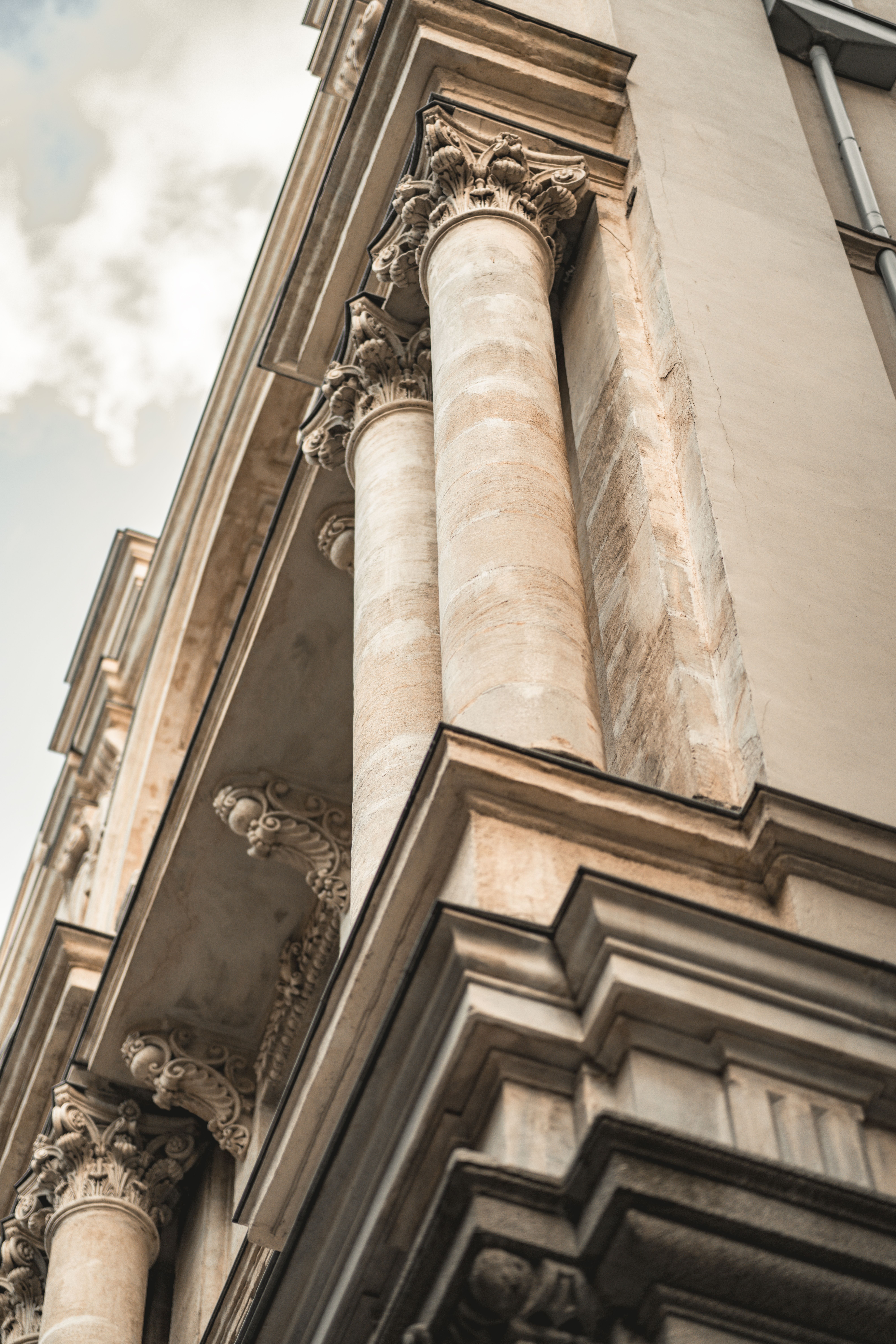 Woman Walking Through Pillars Of A Building · Free Stock Photo