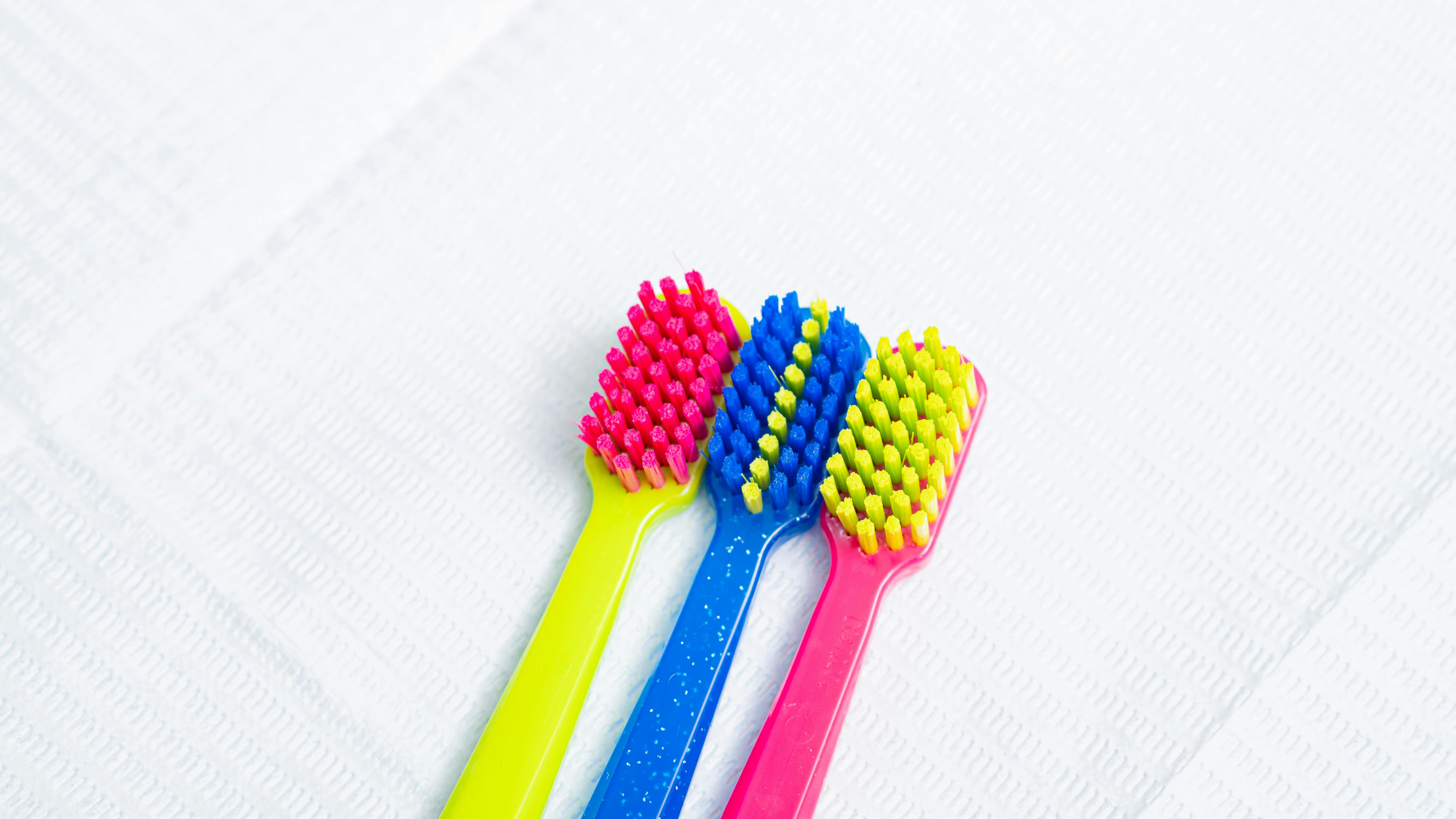 Close up of Colorful Toothbrushes · Free Stock Photo