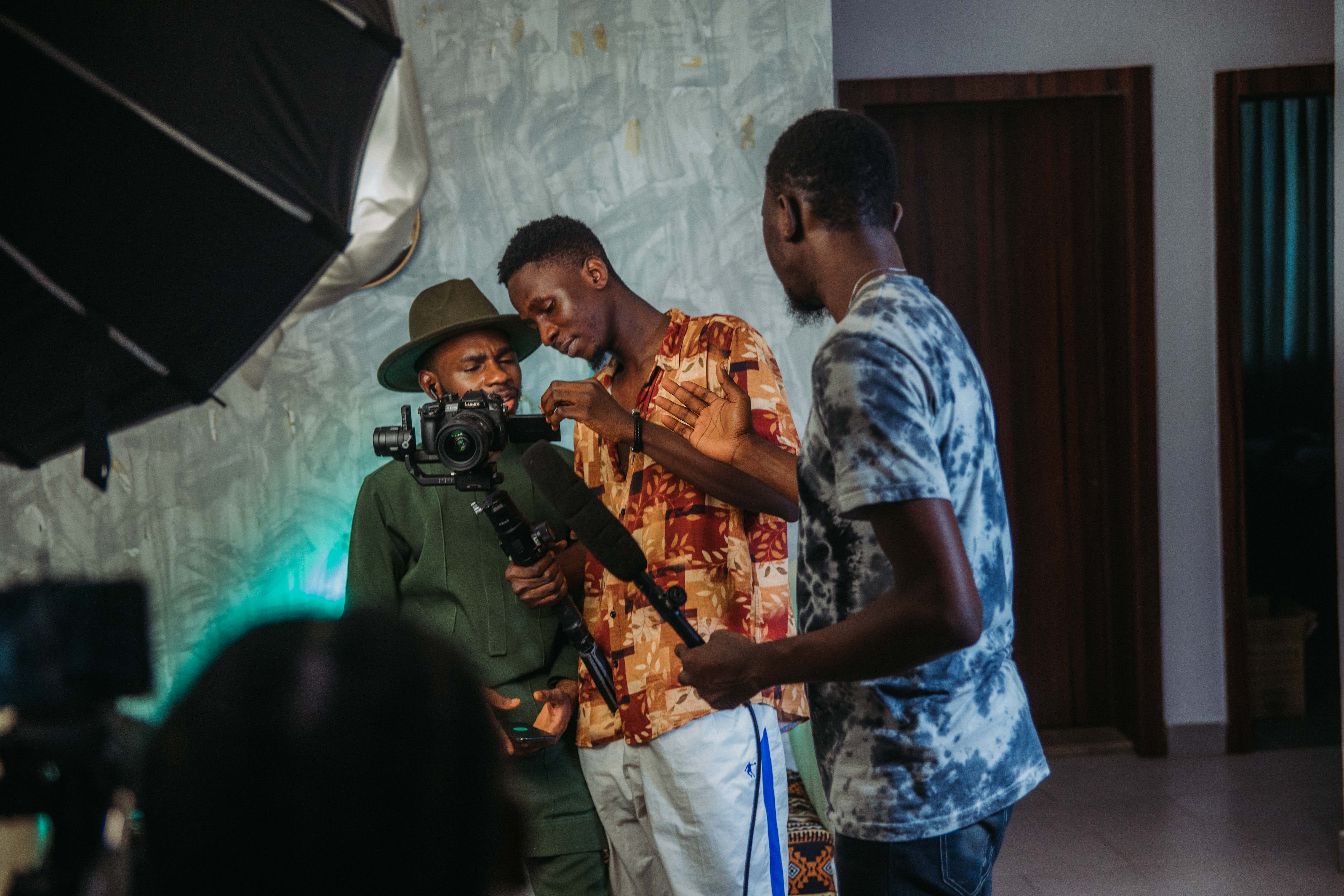 Two men are filming a video in a room · Free Stock Photo