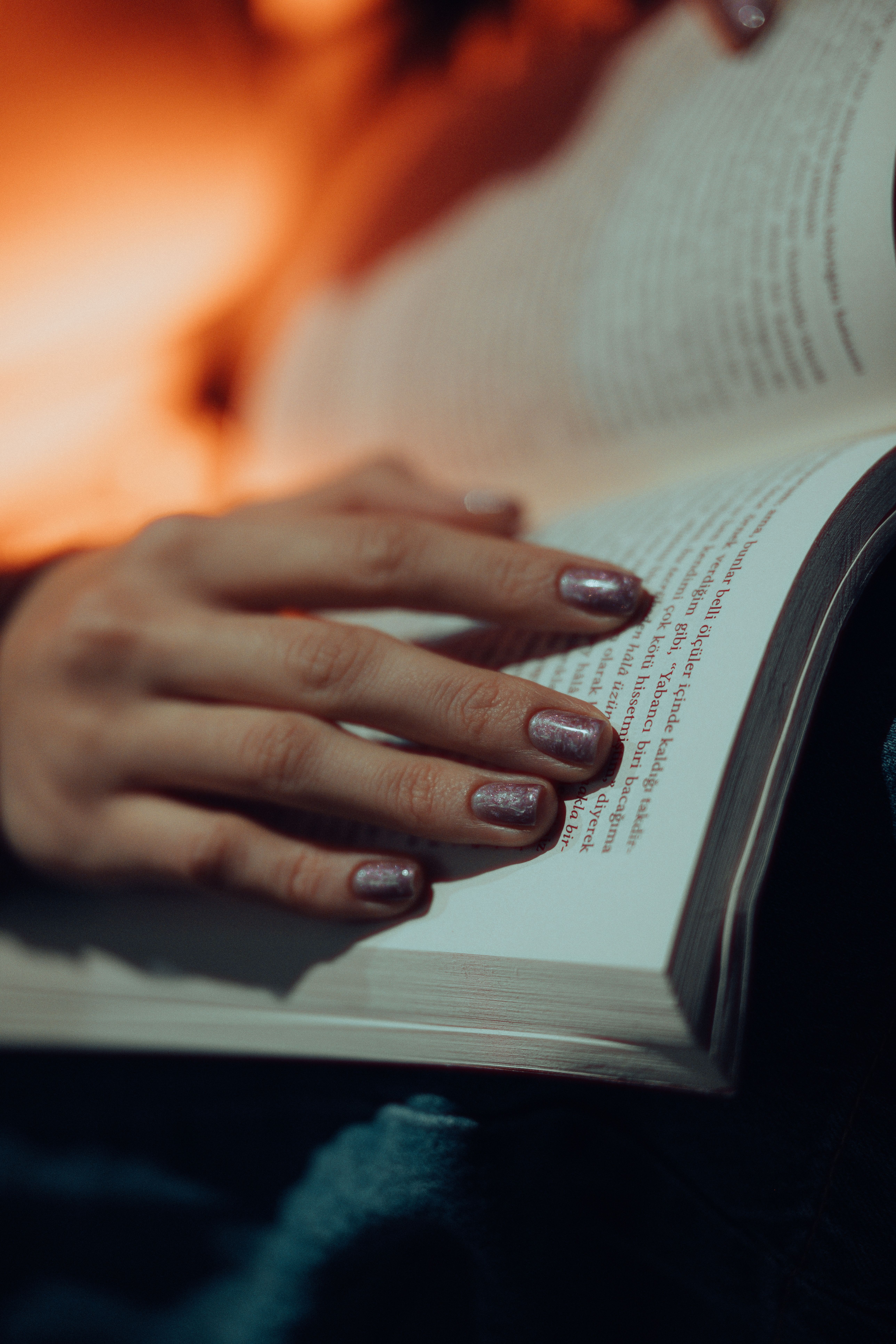 Woman Reading a Book in a Dimly Lit Room · Free Stock Photo