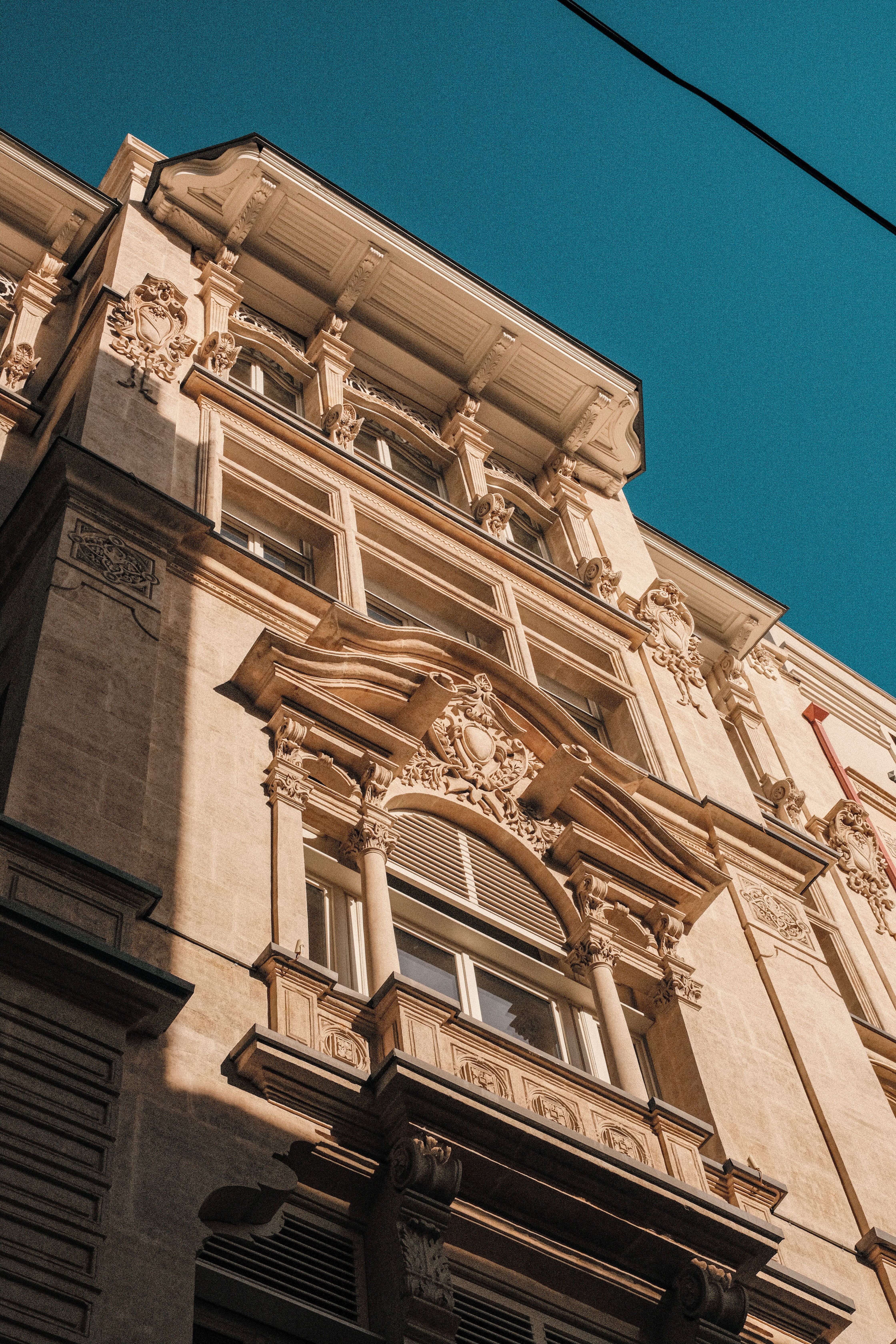 Low Angle Shot of a Building with Carved Details under Blue Sky · Free ...