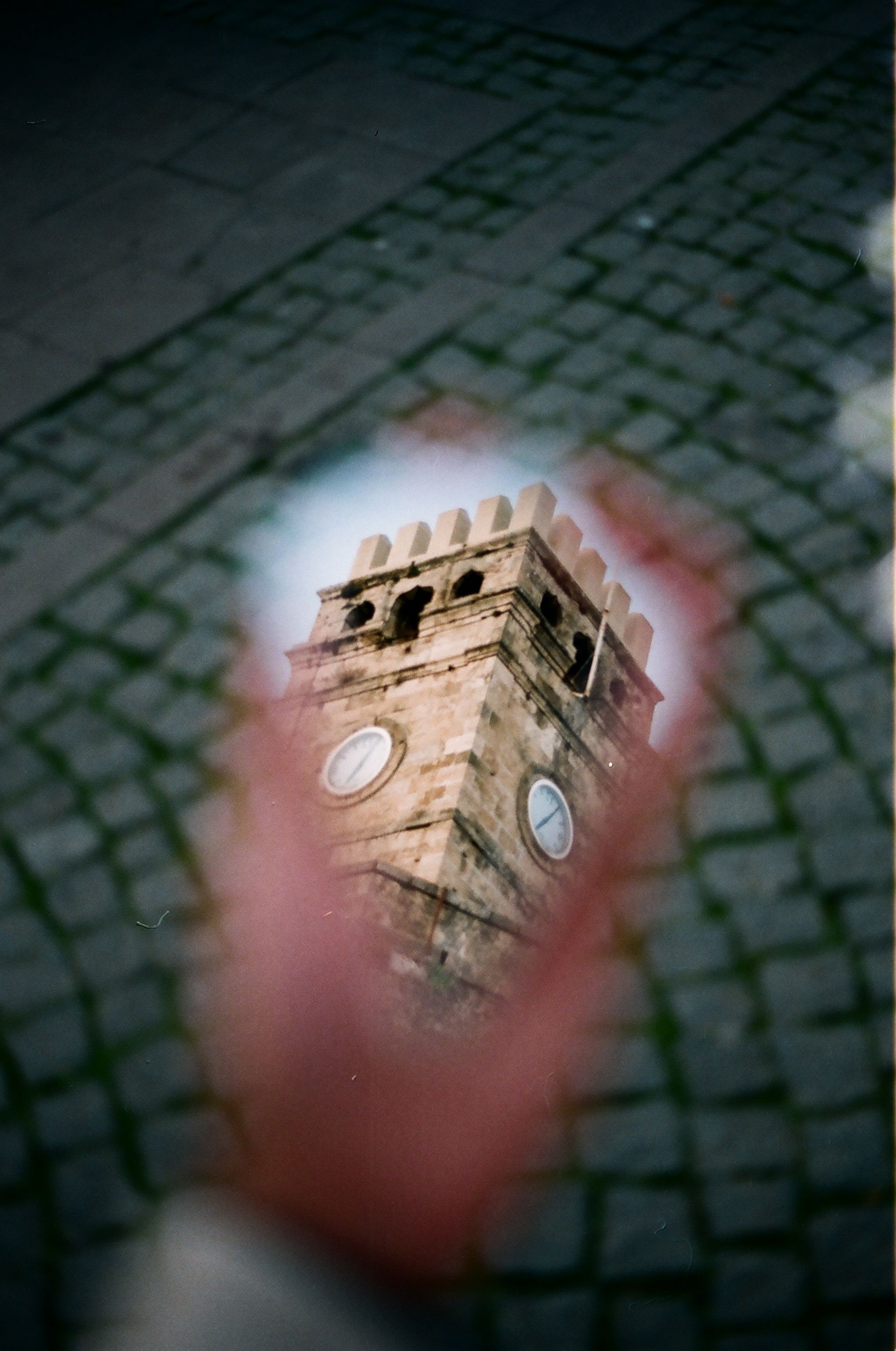 Reflection of the Antalya Saat Kulesi in a Mirror Piece on a Persons ...