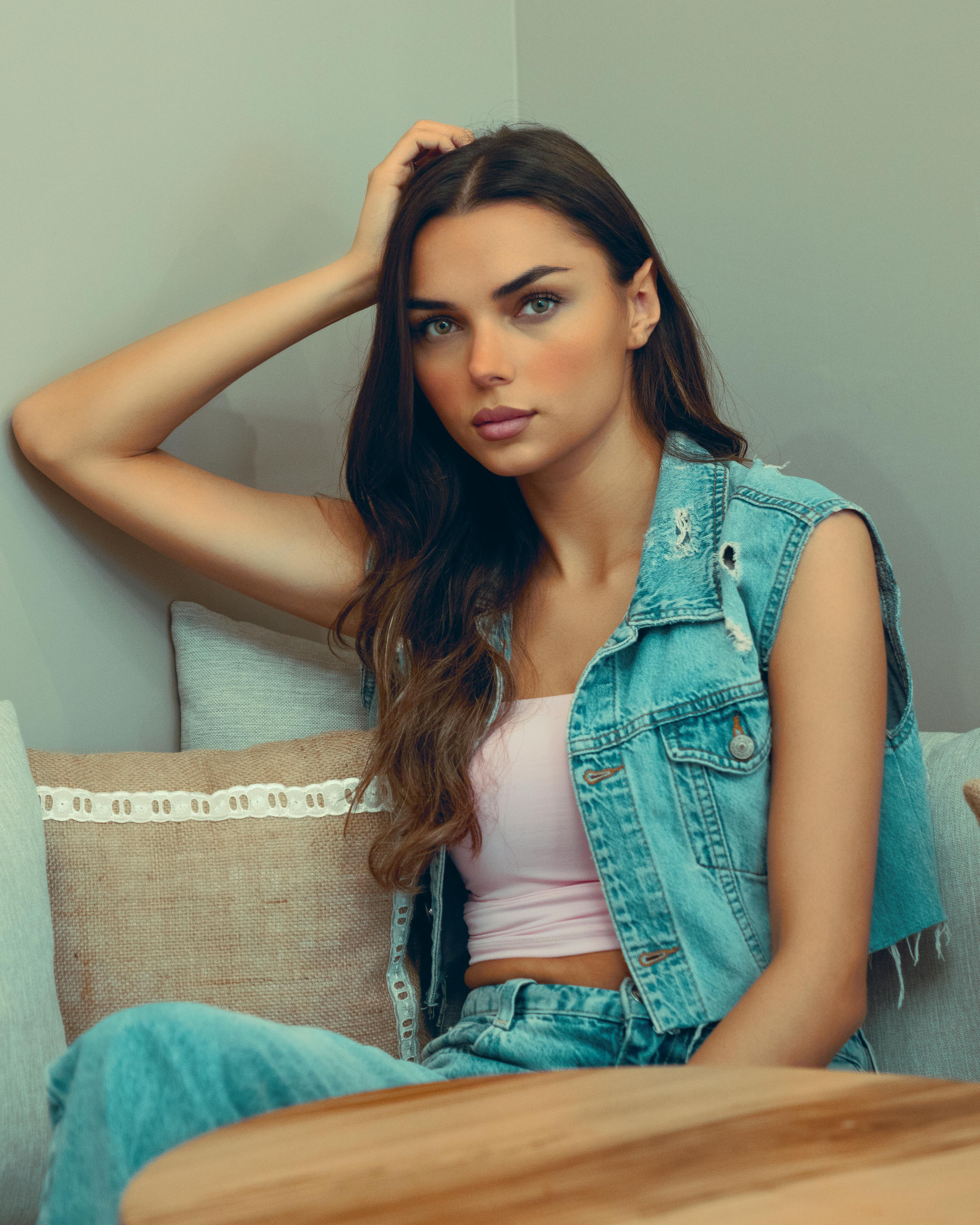 Woman in Denim Vest Fixing Hair · Free Stock Photo