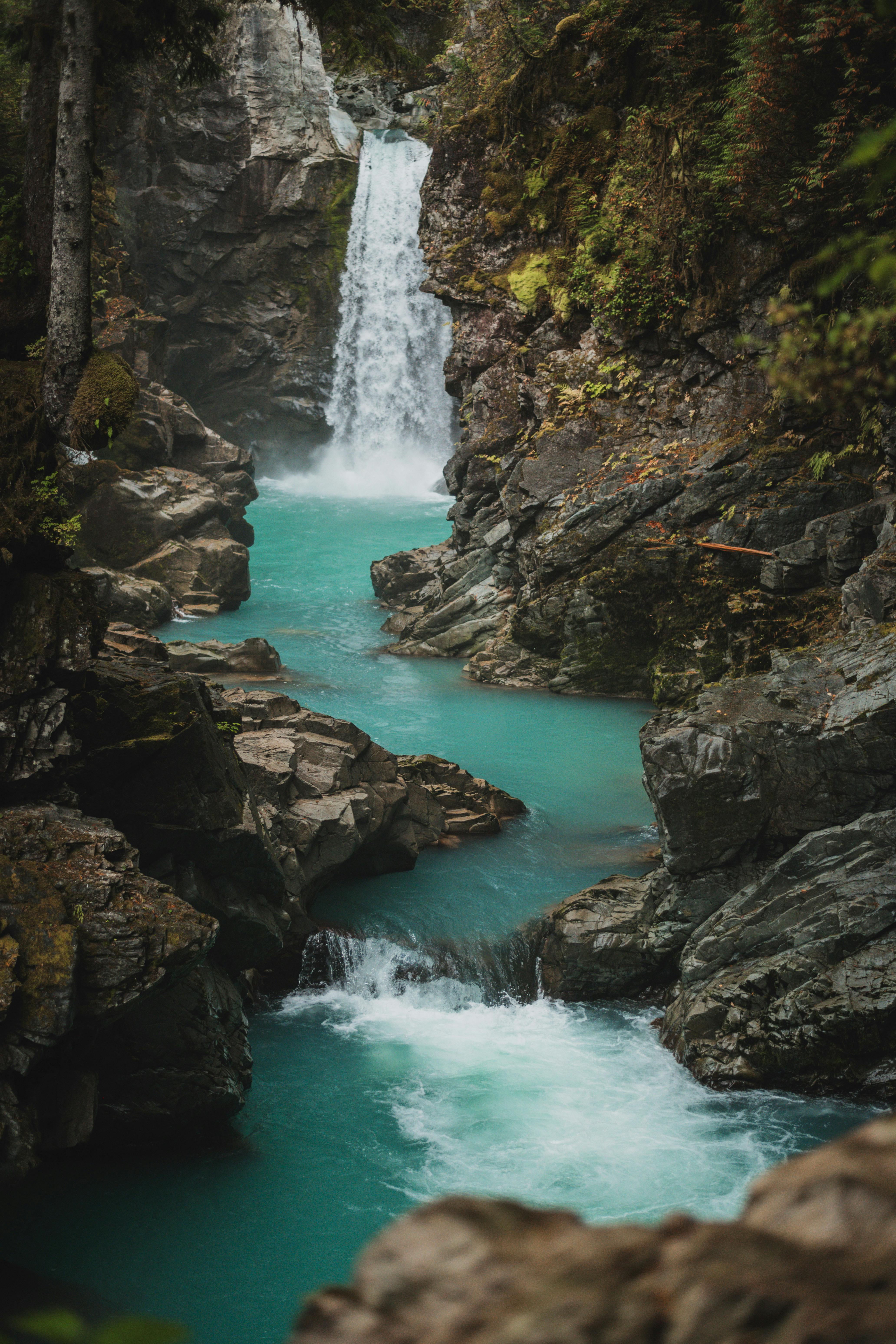 Rocks around Stream and with Waterfall behind · Free Stock Photo