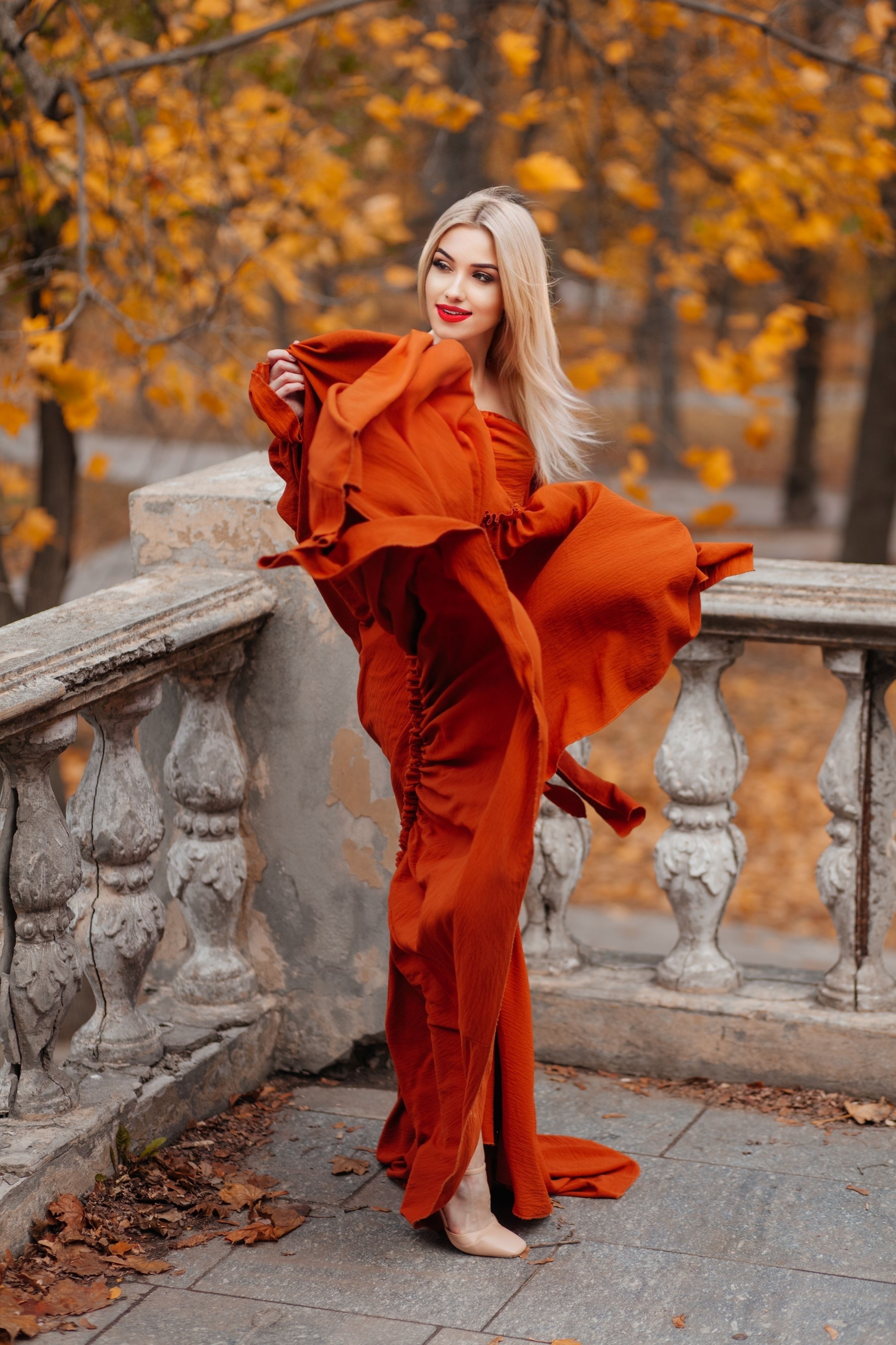 Woman in Red Maxi Dress on Terrace in Autumn · Free Stock Photo