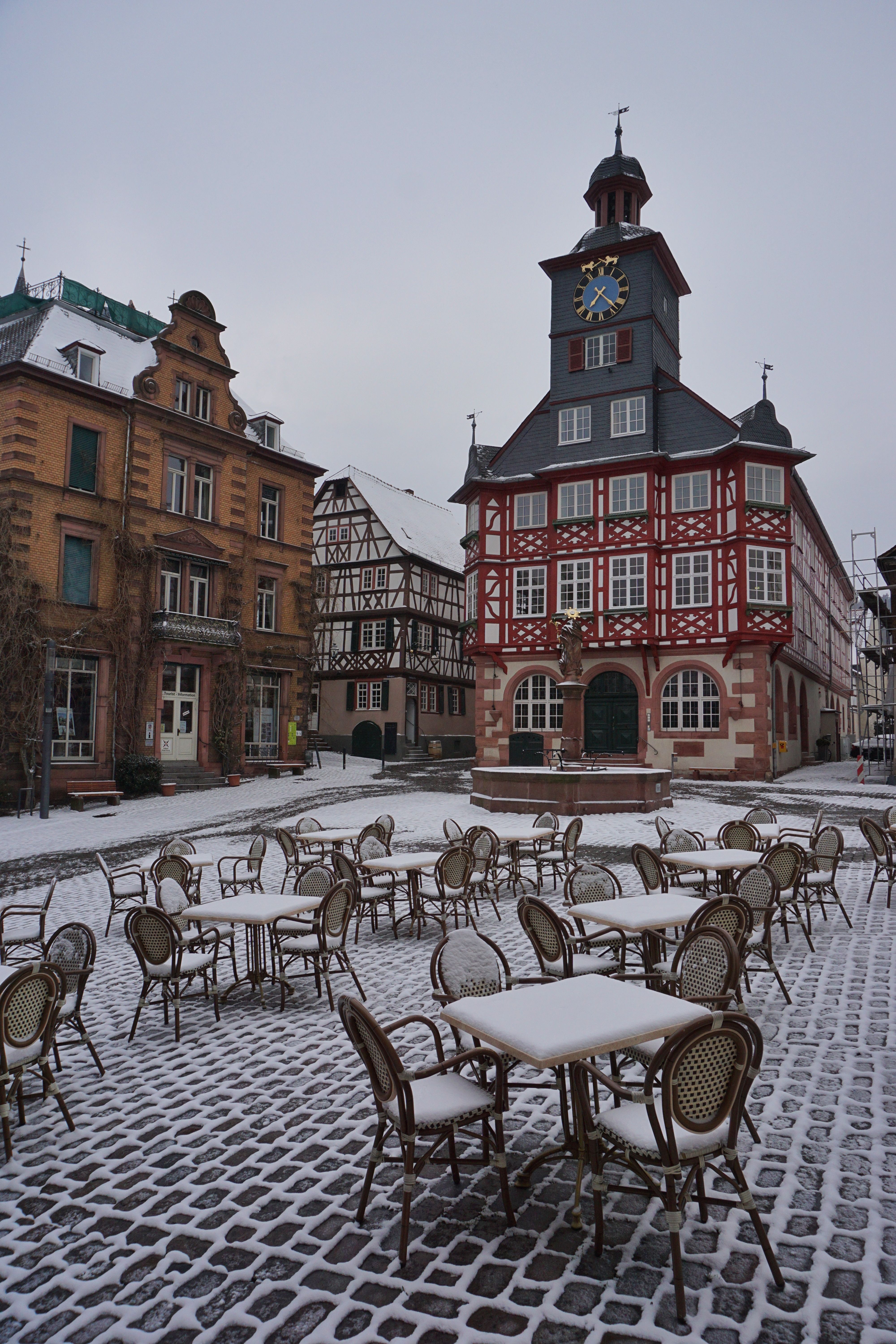 View of Tables and Chairs Standing in the Town Square Covered in Snow ...