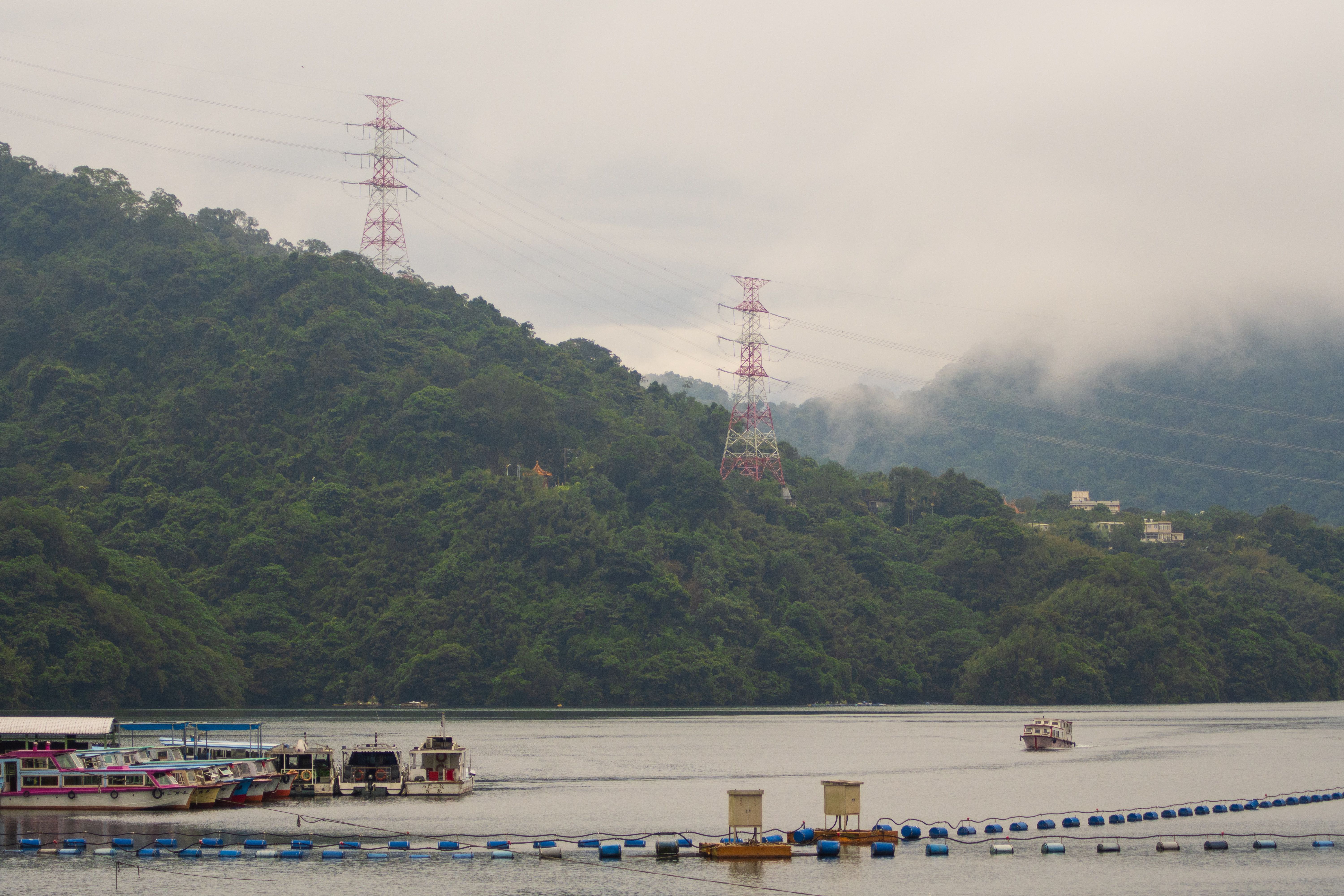 River with Boats and Forest Hills with Electric Poles in Mist · Free ...